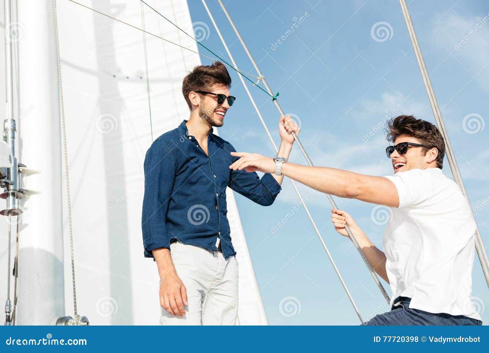 Two Young Handsome Men Talking while Standing on the Yacht Stock Photo ...