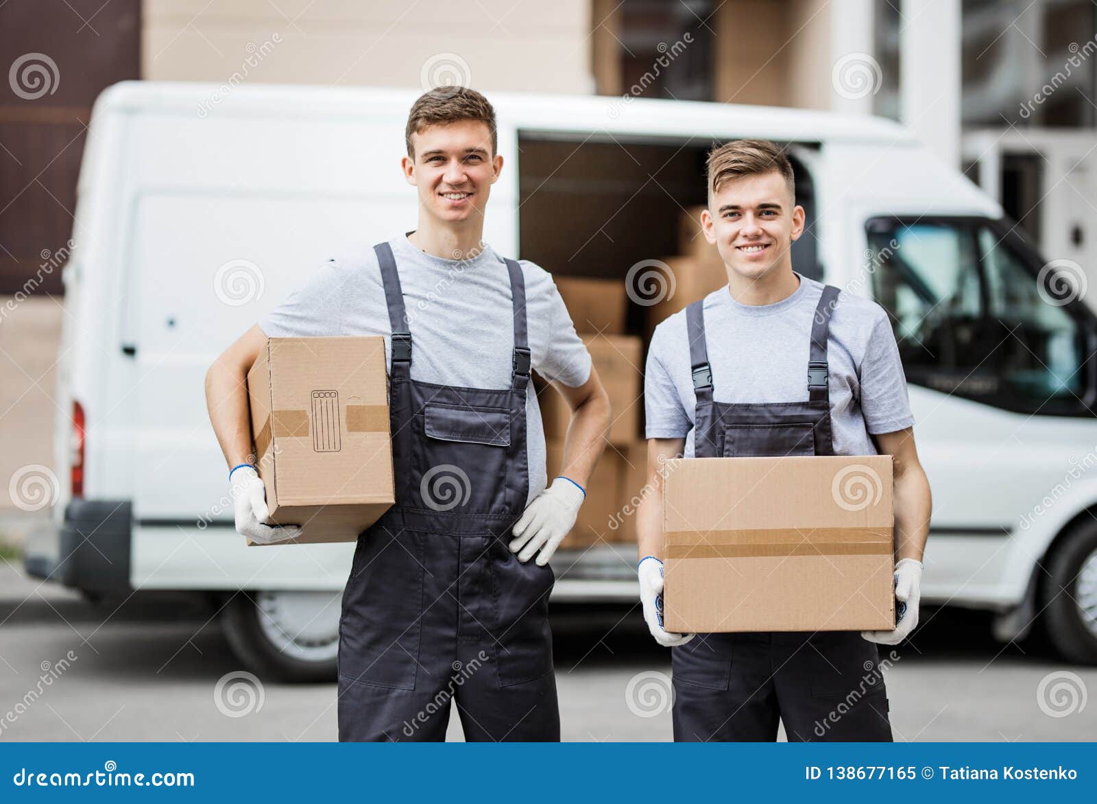 Two Young Handsome Smiling Workers Wearing Uniforms are Standing in ...