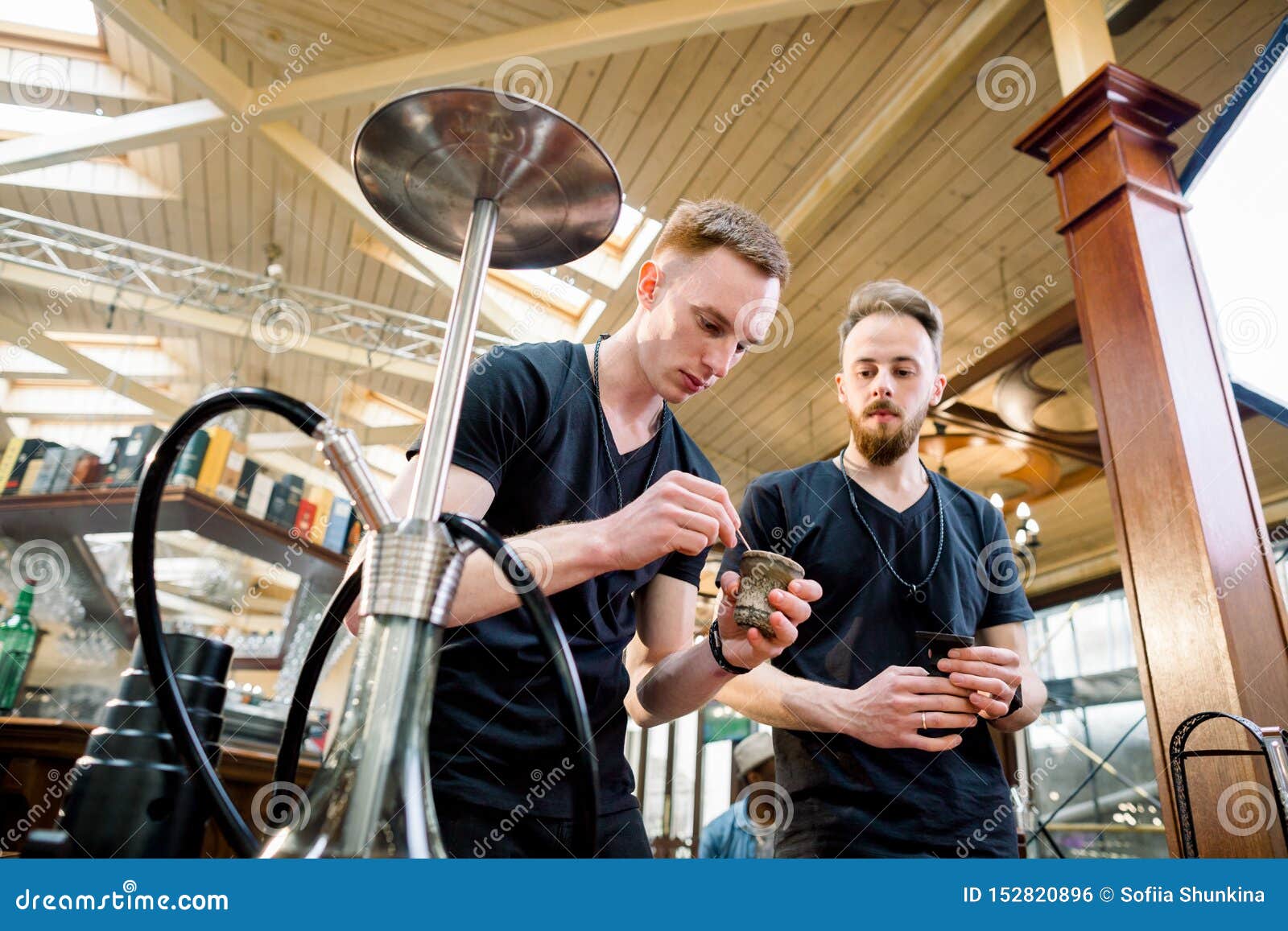 Two Young Hookah Masters at Work Stock Photo - Image of dark, flavor ...