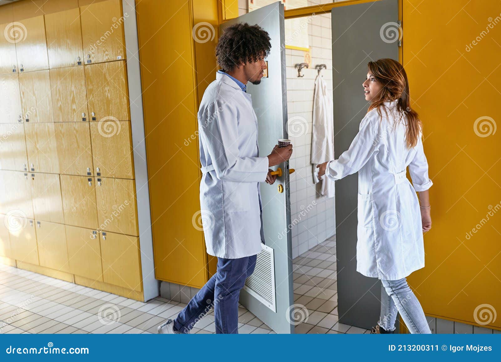 Two Young Interns Entering Dressing Room Stock Image - Image of person ...