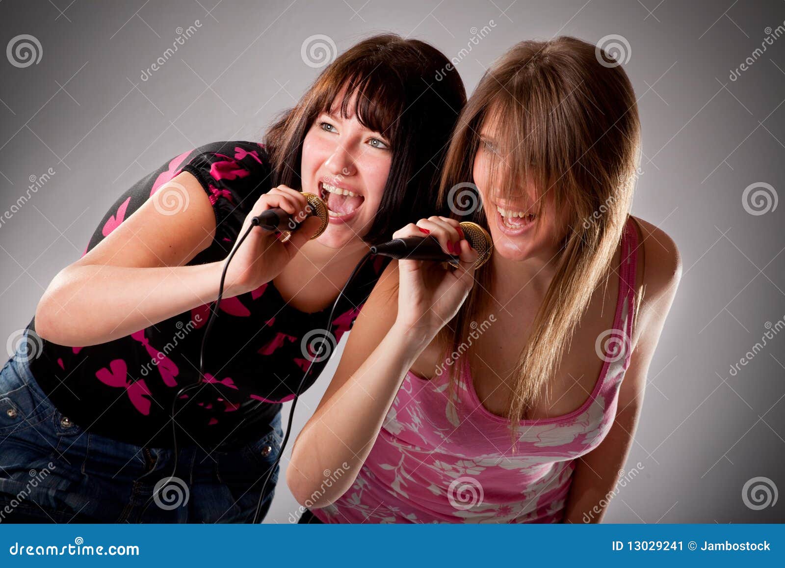 Two young karaoke girls stock image. Image of background - 13029241