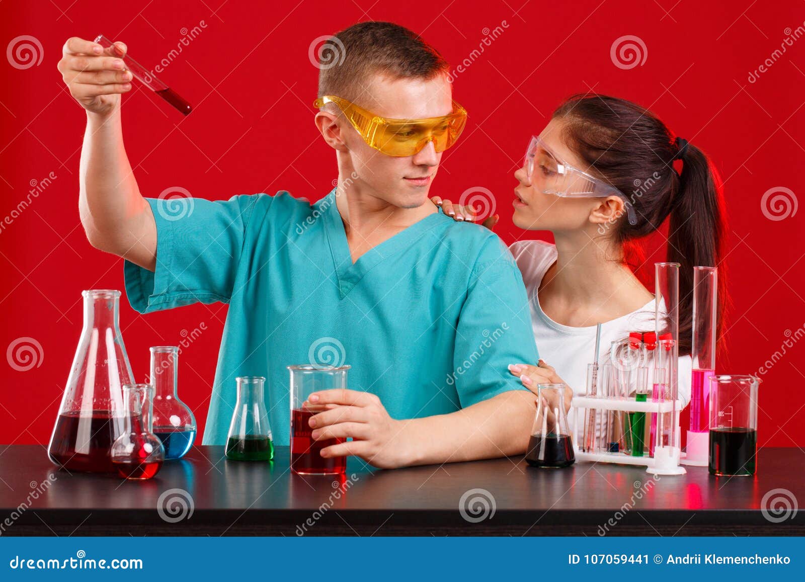 Two Lab Technicians in Uniform, Looking at Each Other, a Guy Holding a ...