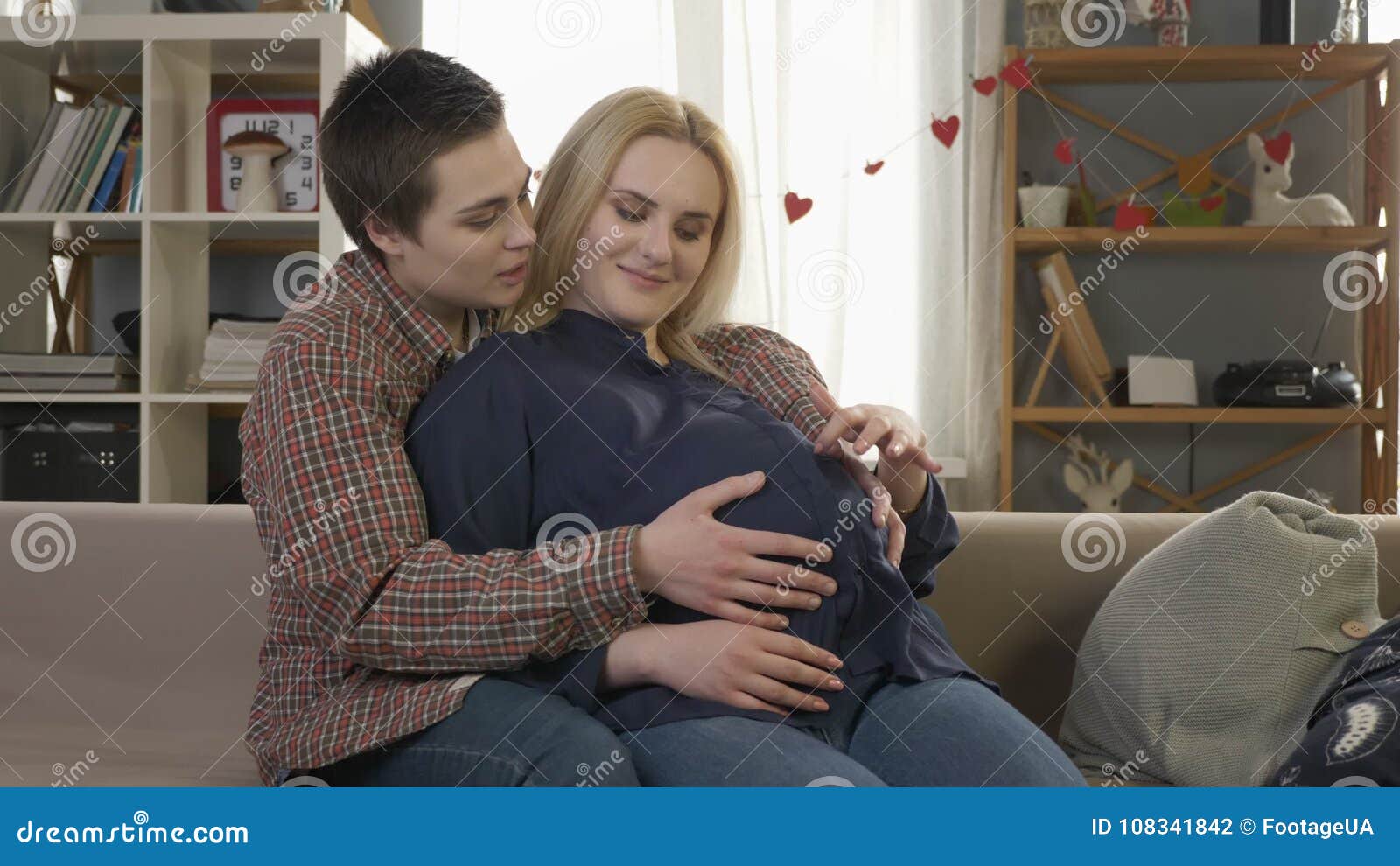 Two Young Lesbian Girls Sitting On The Couch Pregnant Blonde Caresses