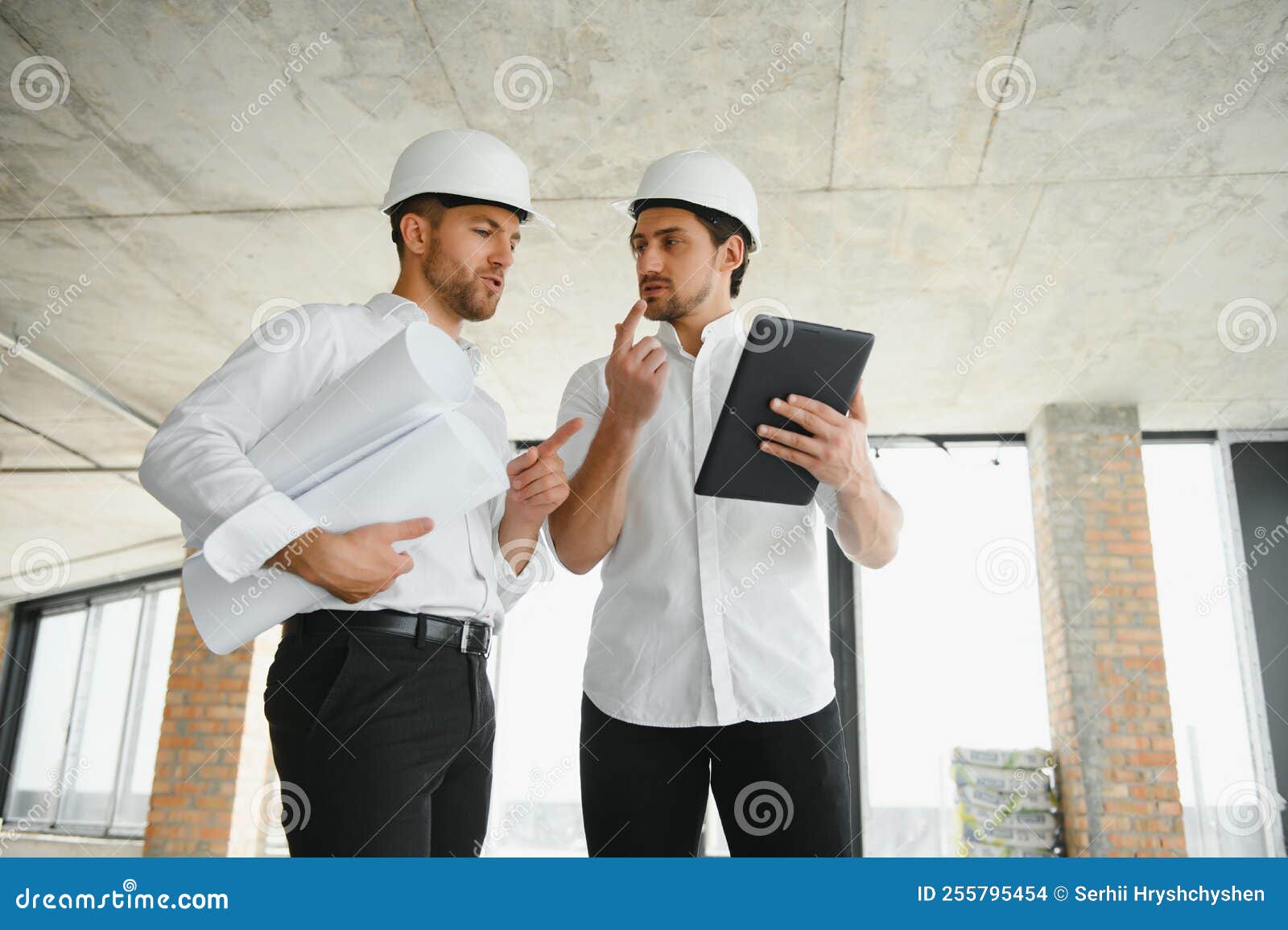 Two Young Man Architect on a Building Construction Site Stock Photo ...