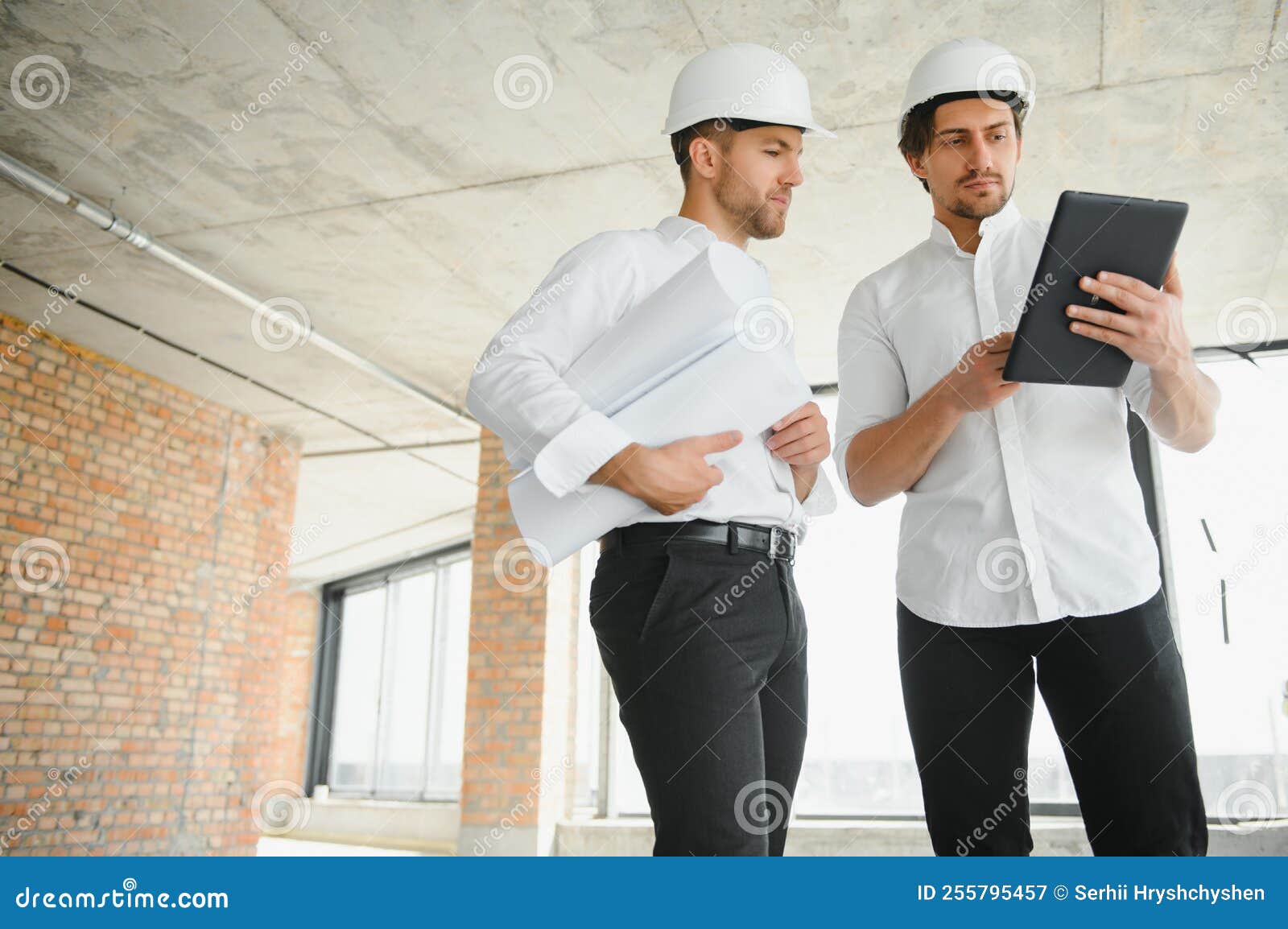 Two Young Man Architect on a Building Construction Site Stock Image ...