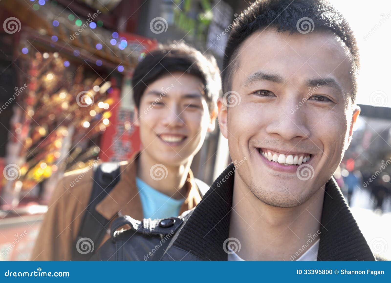 Two Young Men with Chinese Architecture in Background. Stock Photo ...