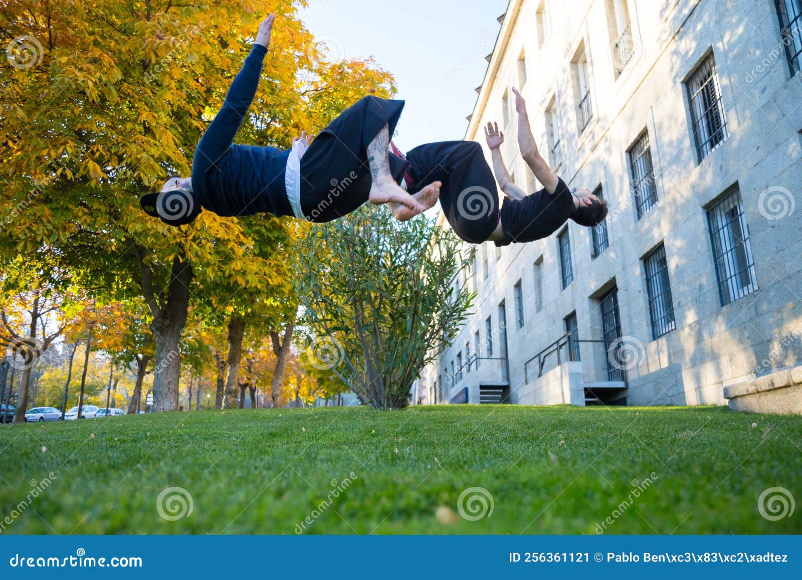 Two Young Men Doing a Side Flip Stock Image - Image of achievement ...
