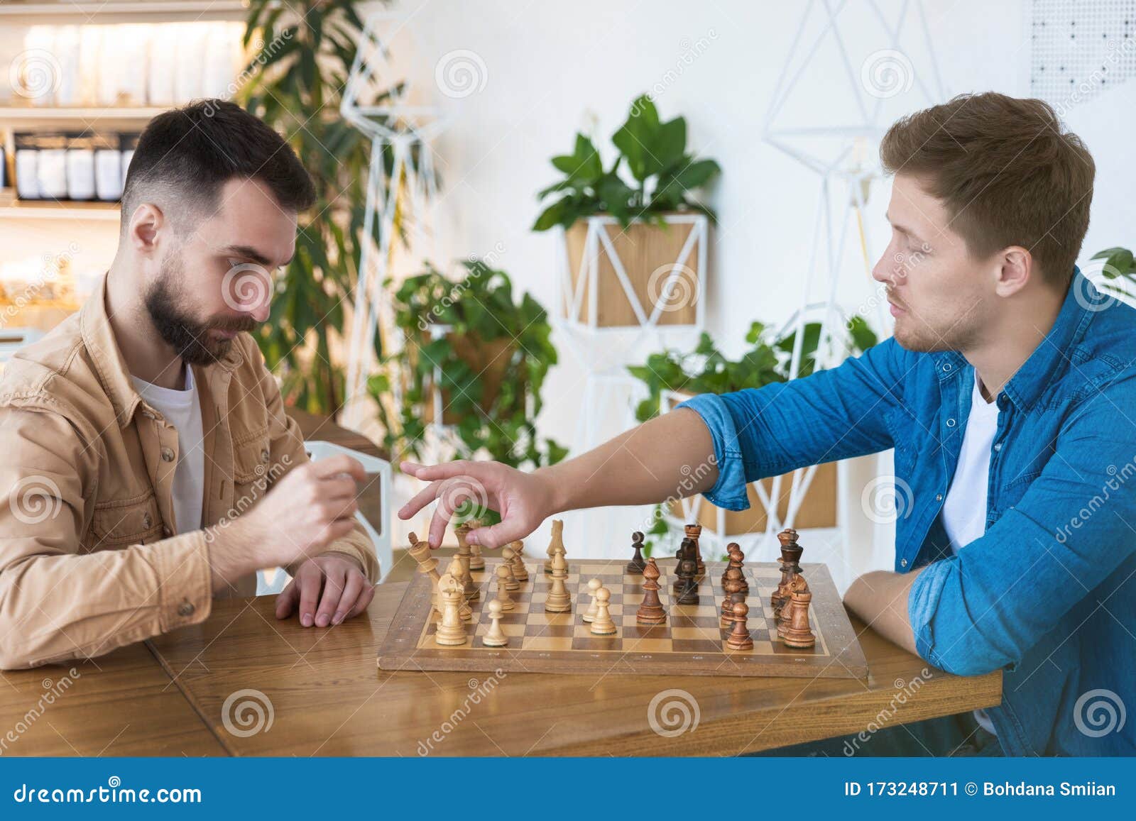 Two Young Men Friends Playing Chess in the Cafe, Intellectual Activity ...