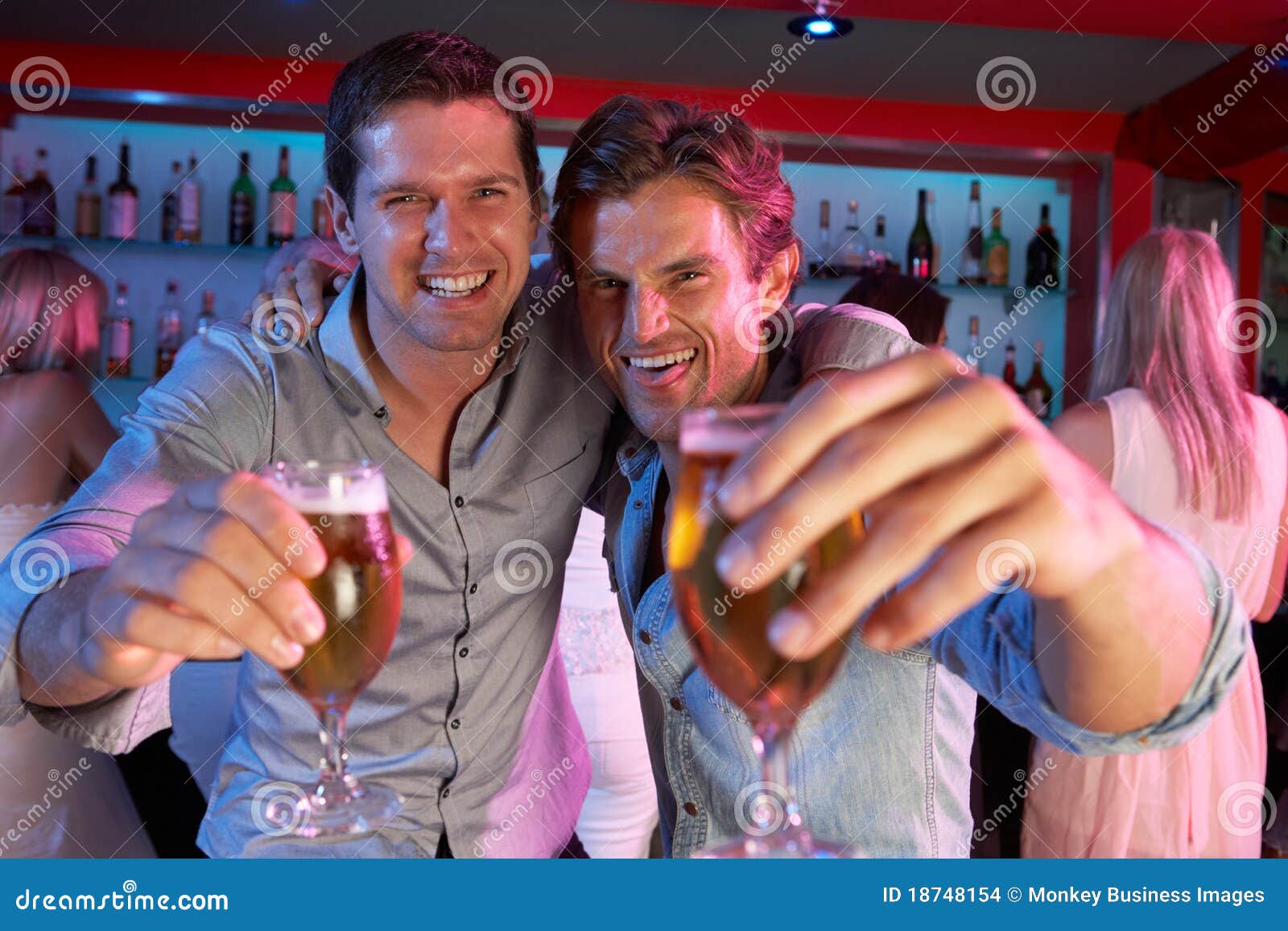 Two Young Men Having Fun in Busy Bar Stock Photo - Image of portrait ...