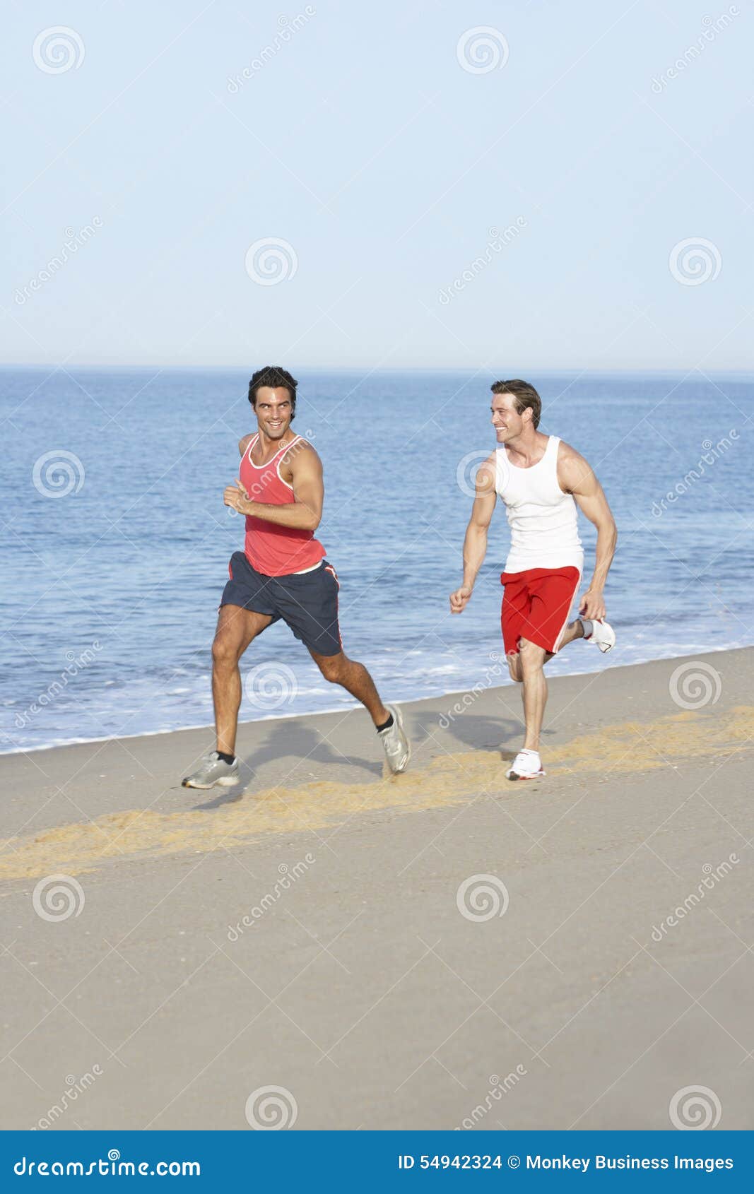 Two Young Men Jogging Along Beach Stock Photo - Image of male, outdoors ...
