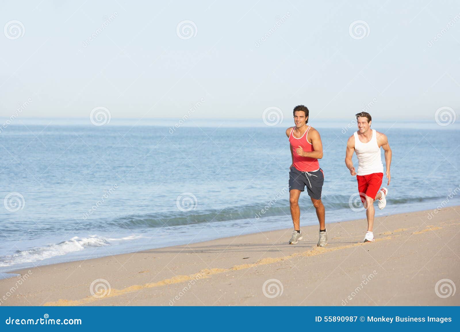 Two Young Men Jogging Along Beach Stock Image - Image of seaside ...