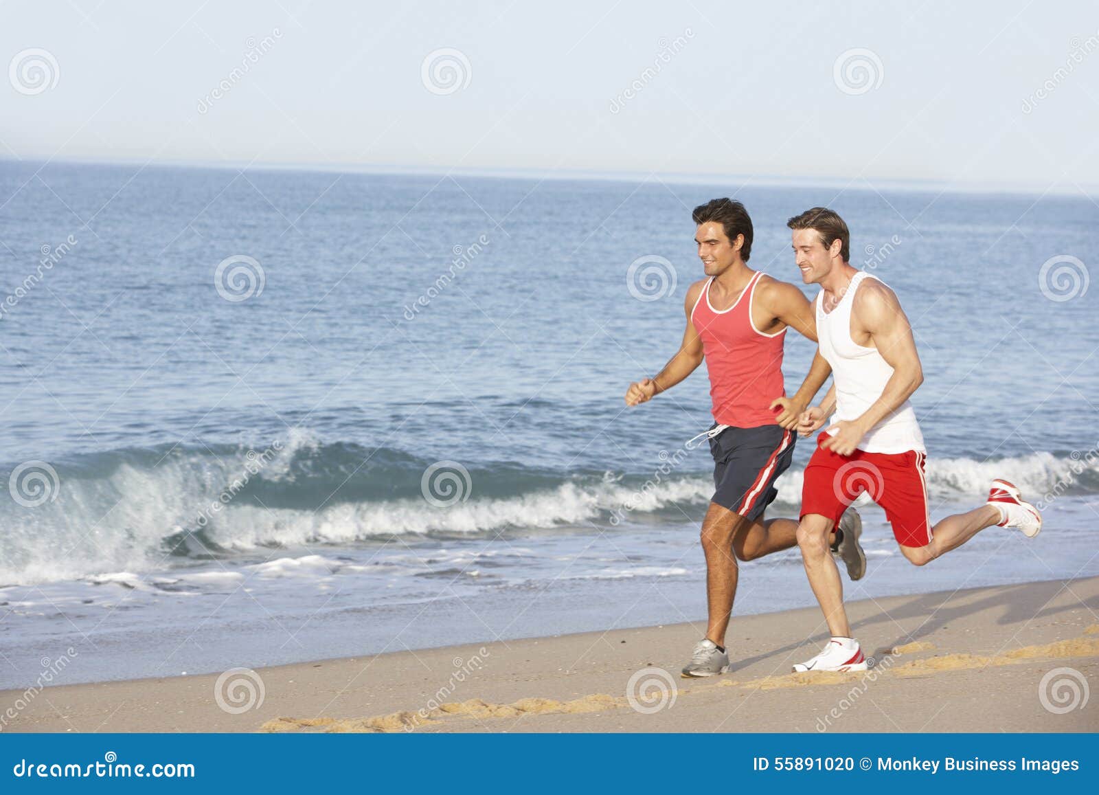 Two Young Men Jogging Along Beach Stock Photo - Image of racing ...