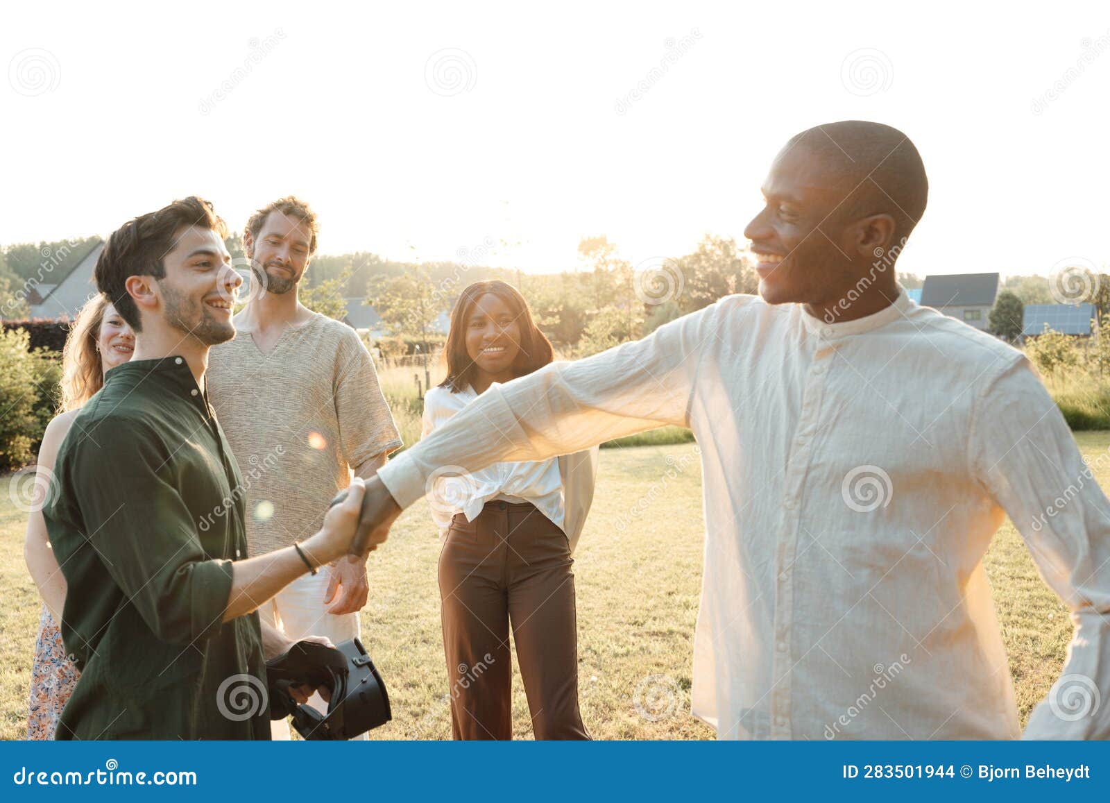 Two Young Men from a Multi-Ethnic Group Shaking Hands after a Virtual ...