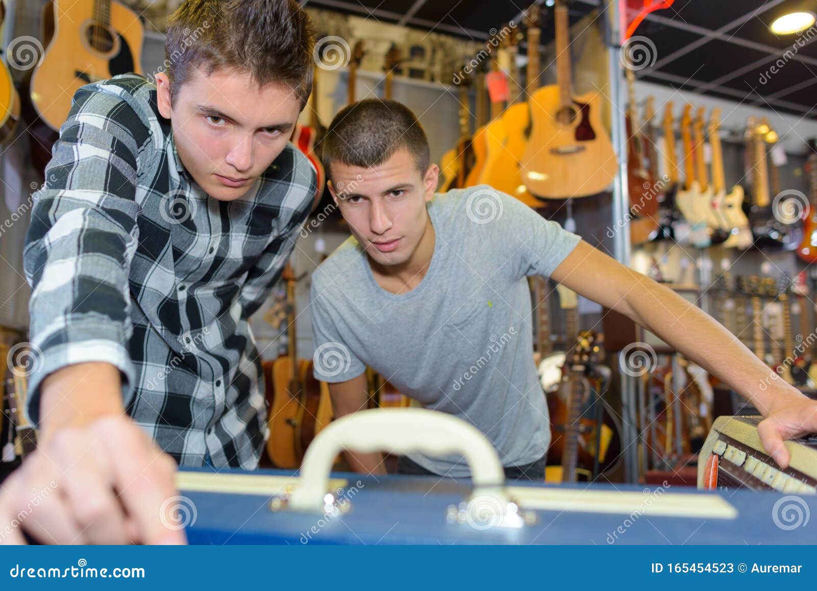 Two Young Men in Musical Instrument Shop Stock Image - Image of case ...