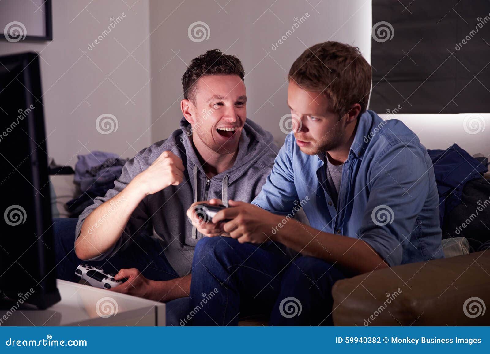 Two Young Men Playing Video Game at Home Stock Photo - Image of living ...