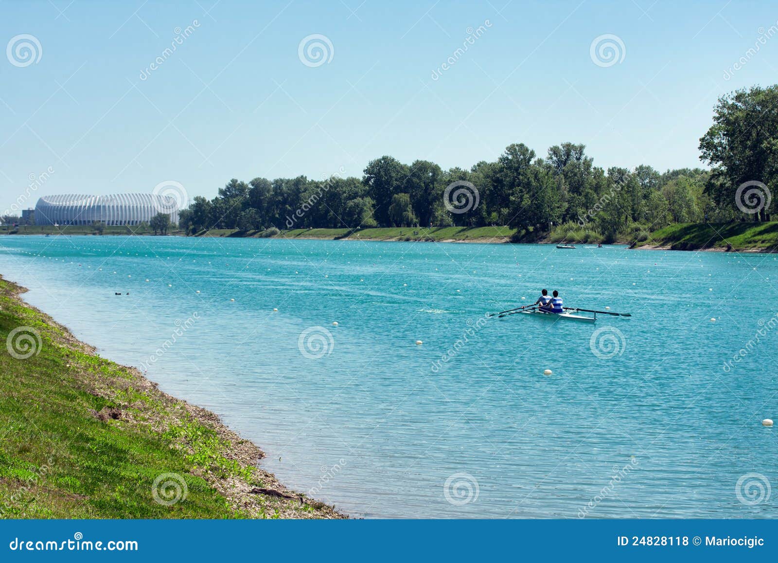 Two young men rowing stock photo. Image of lake, blue - 24828118