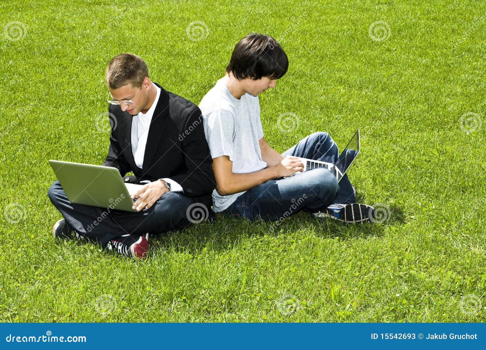 Two Young Men Sitting on Grass with Their Laptops Stock Image - Image ... Two Young Men Sitting on Grass with Their Laptops Stock Image - Image ...