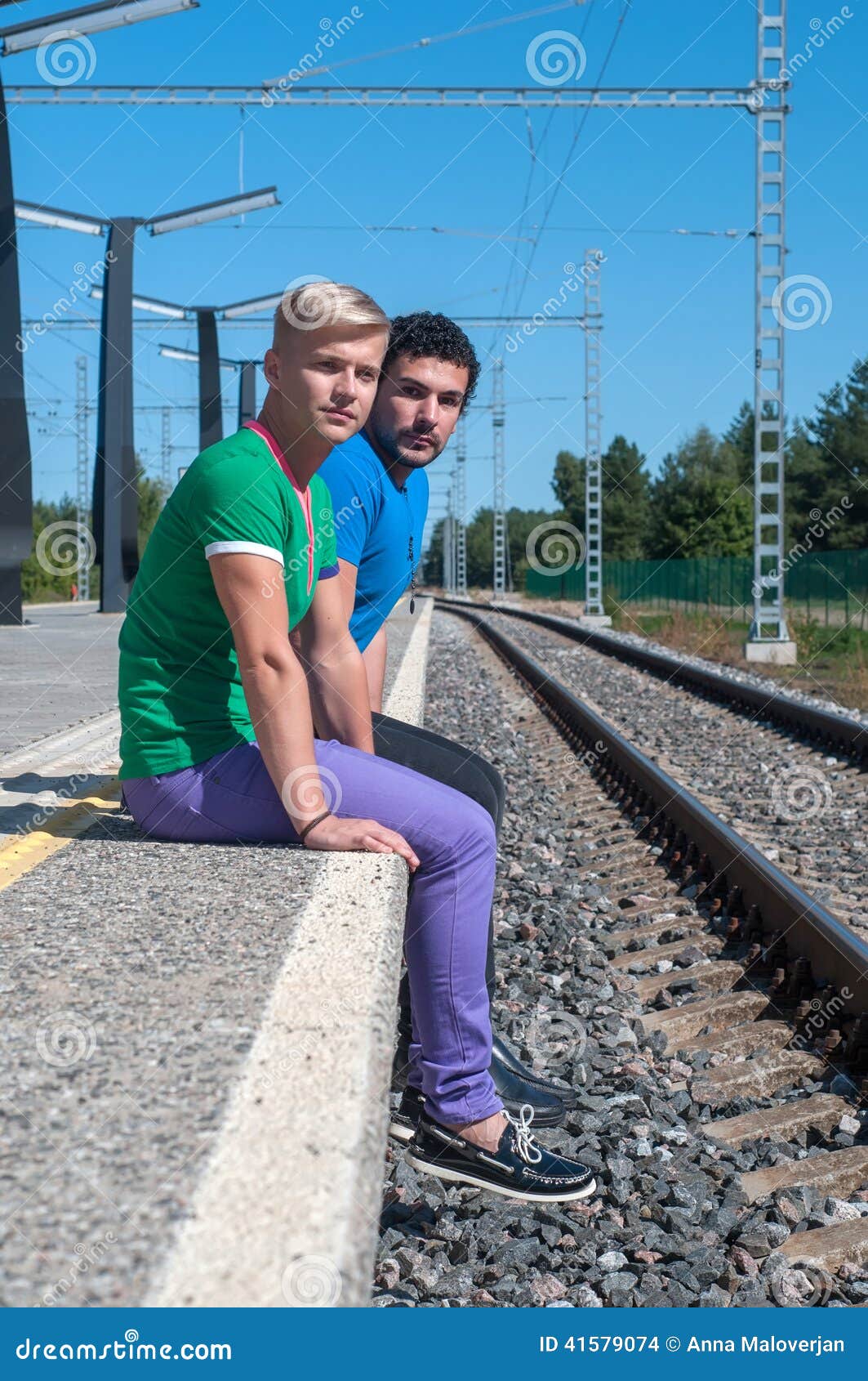 Two Young Men Sitting on the Platform Stock Photo - Image of adult ...