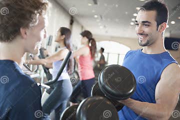 Two Young Men Smiling and Lifting Weights in the Gym Stock Photo ...