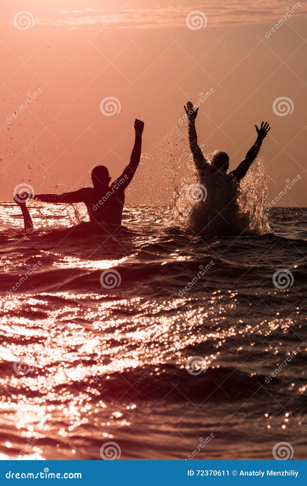 Two Young Men Splashing Water in the Sea Stock Image - Image of light ...