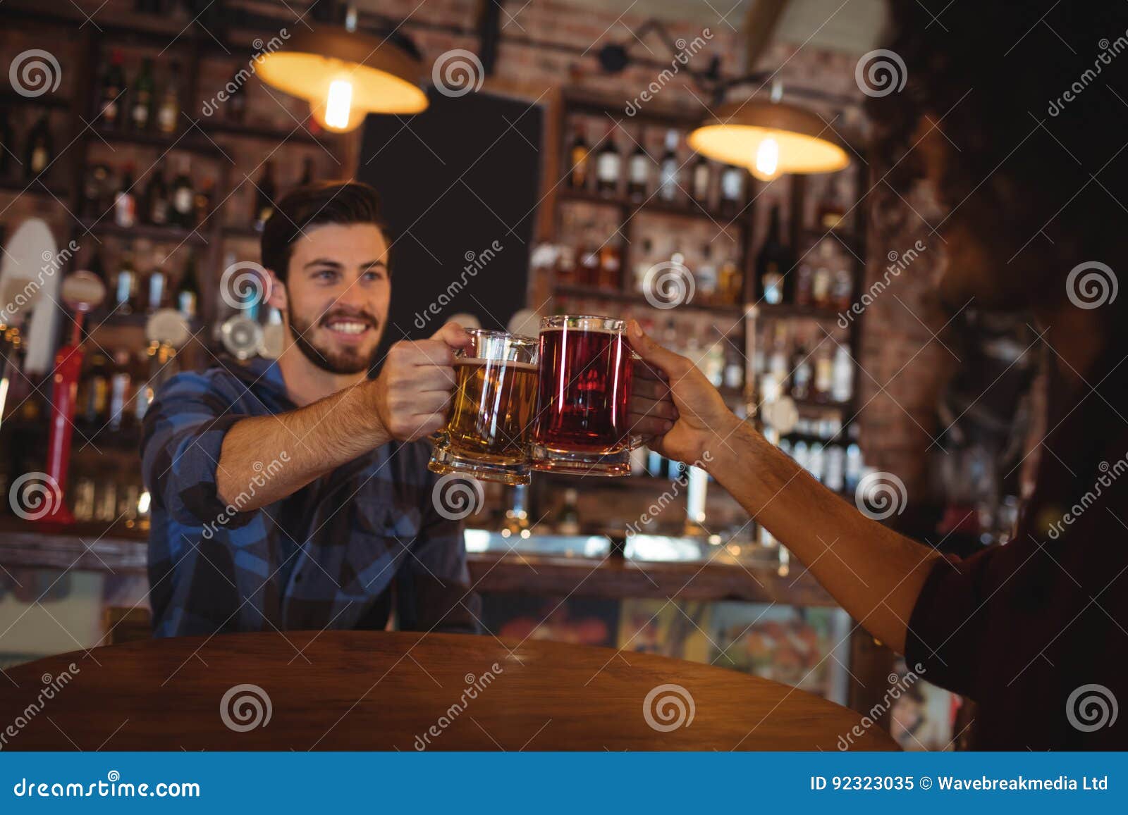 Two Young Men Toasting Their Beer Mugs Stock Image - Image of enjoyment ...