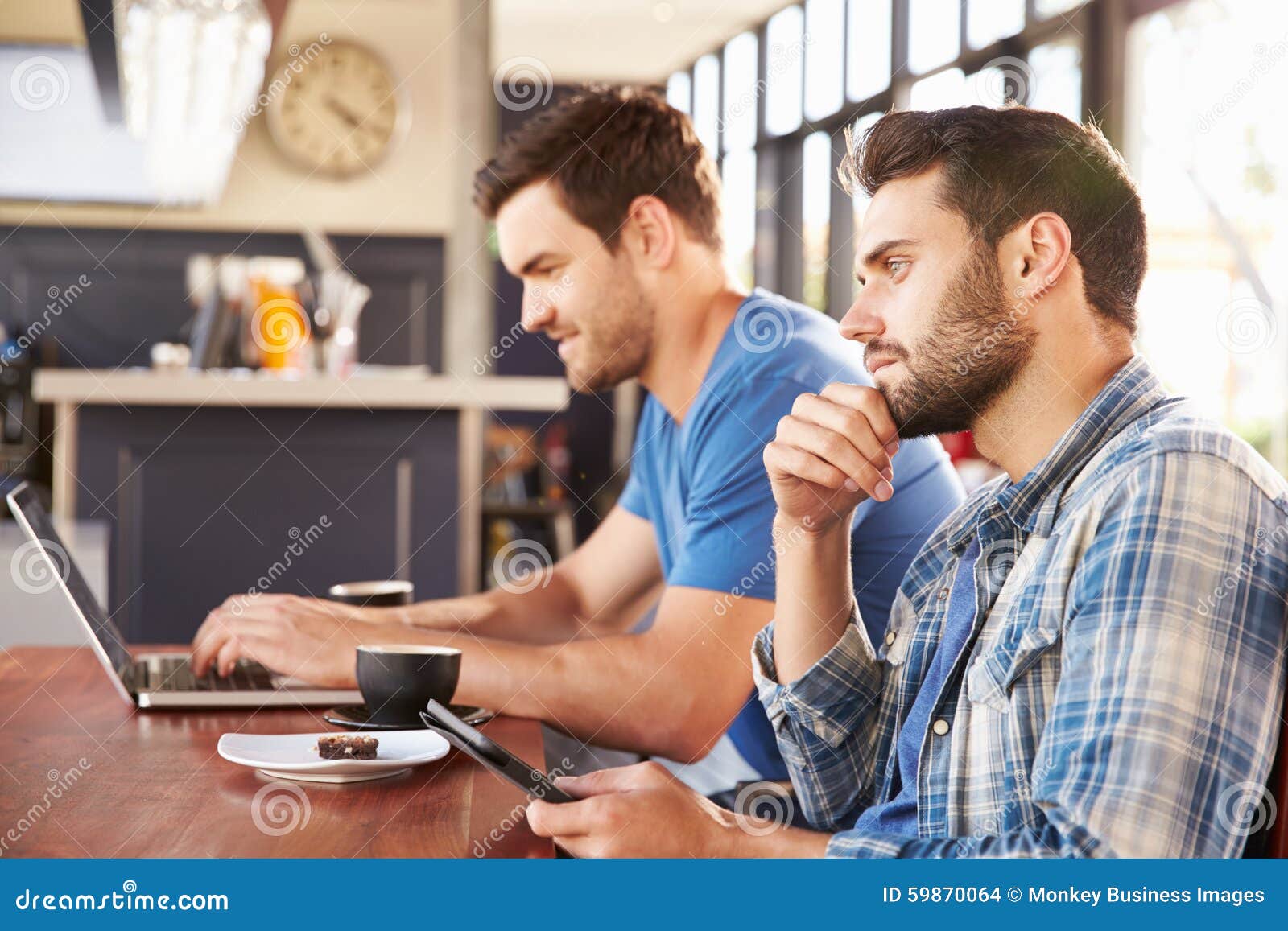 Two Young Men Working on Computers at a Coffee Shop Stock Photo - Image ...