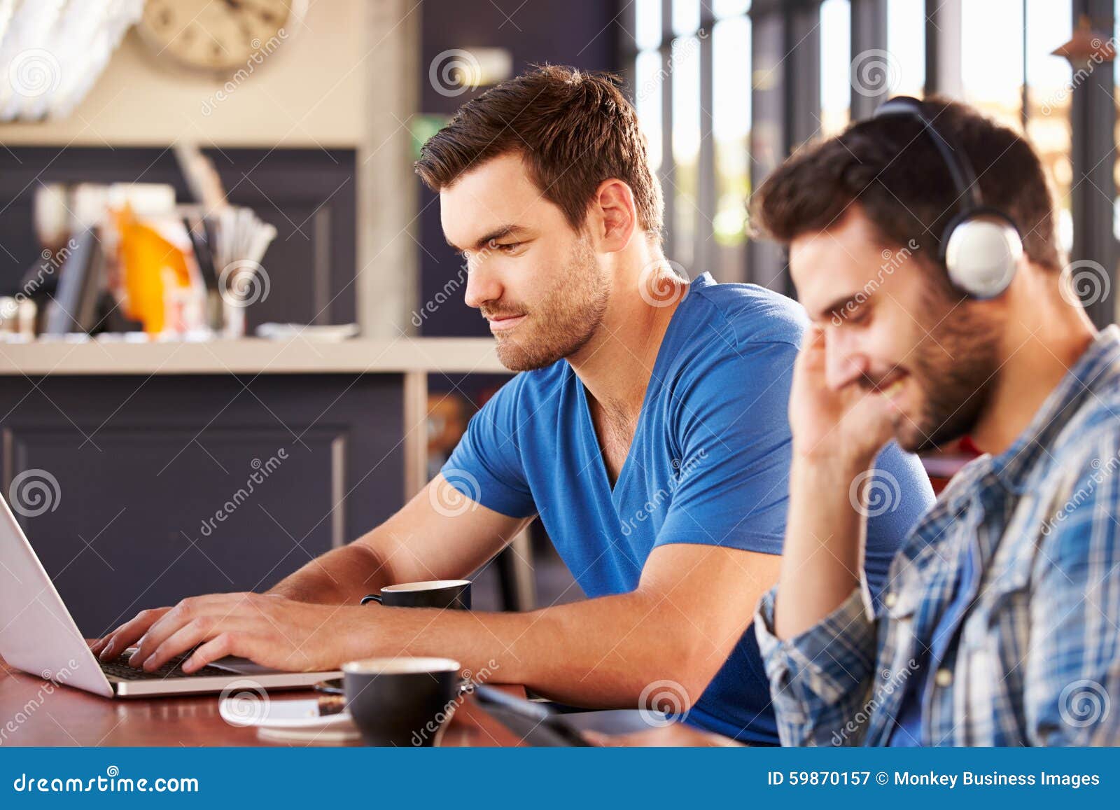 Two Young Men Working on Computers at a Coffee Shop Stock Image - Image ...