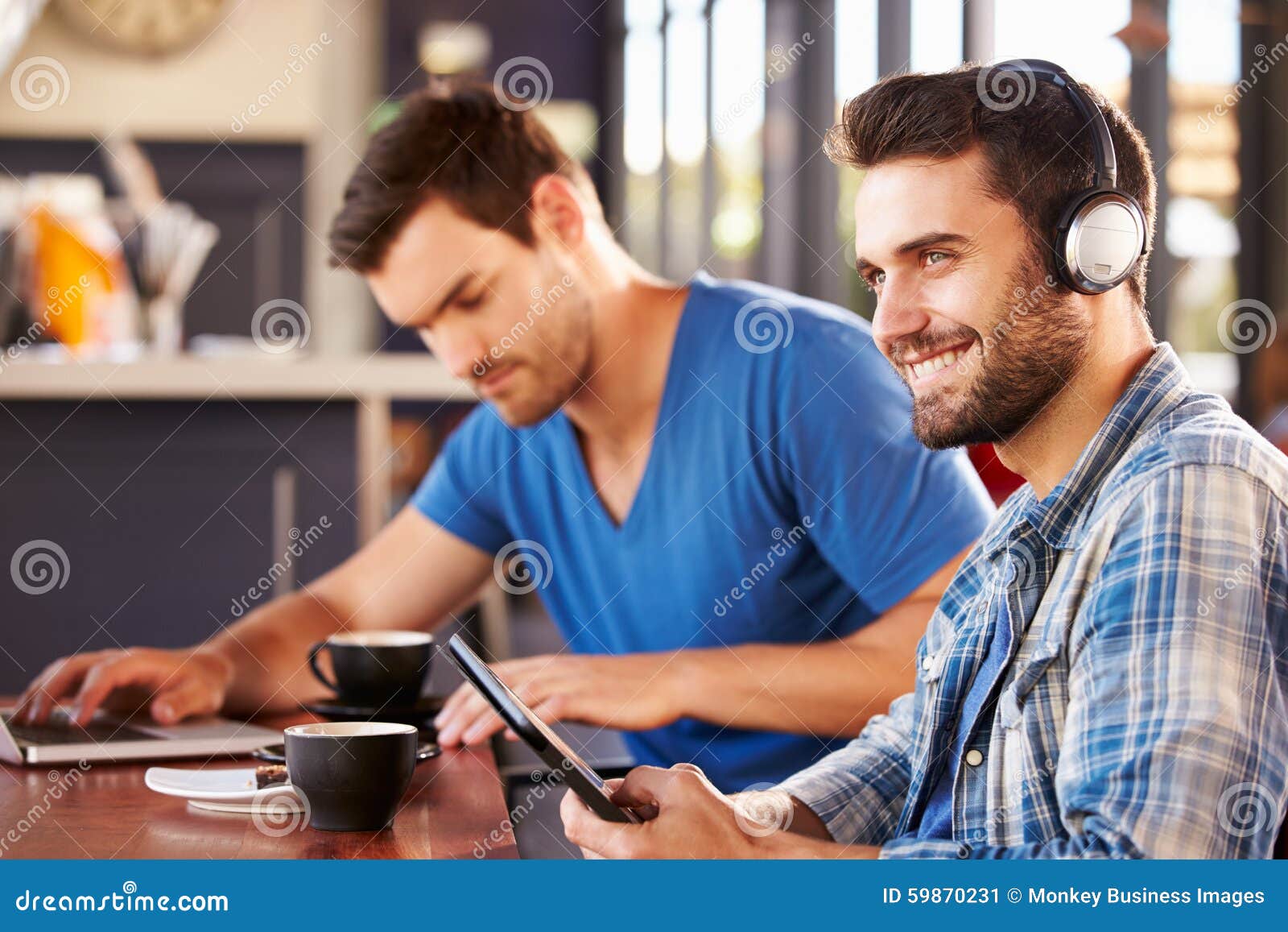 Two Young Men Working on Computers at a Coffee Shop Stock Image - Image ...