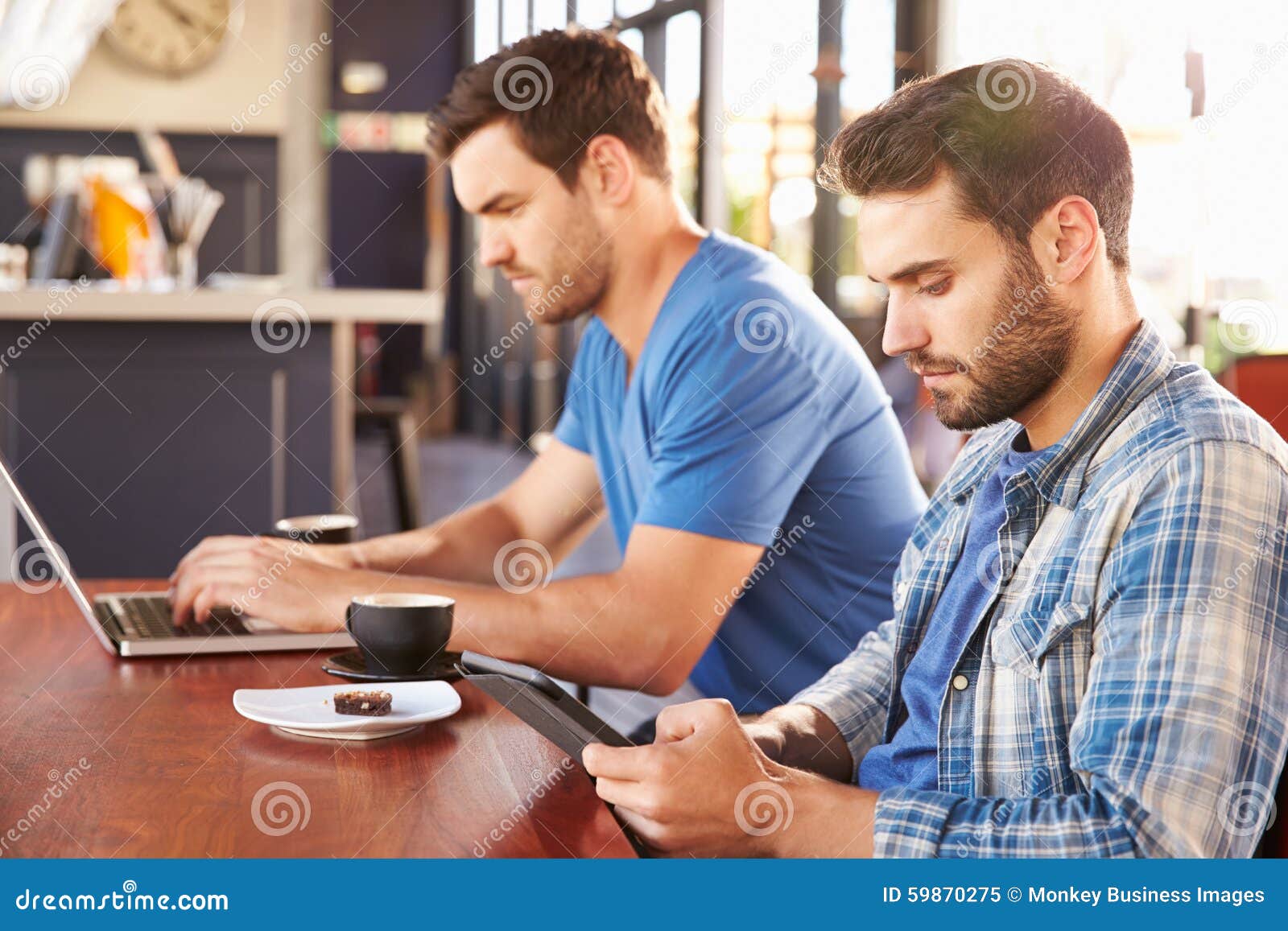 Two Young Men Working on Computers at a Coffee Shop Stock Image - Image ...