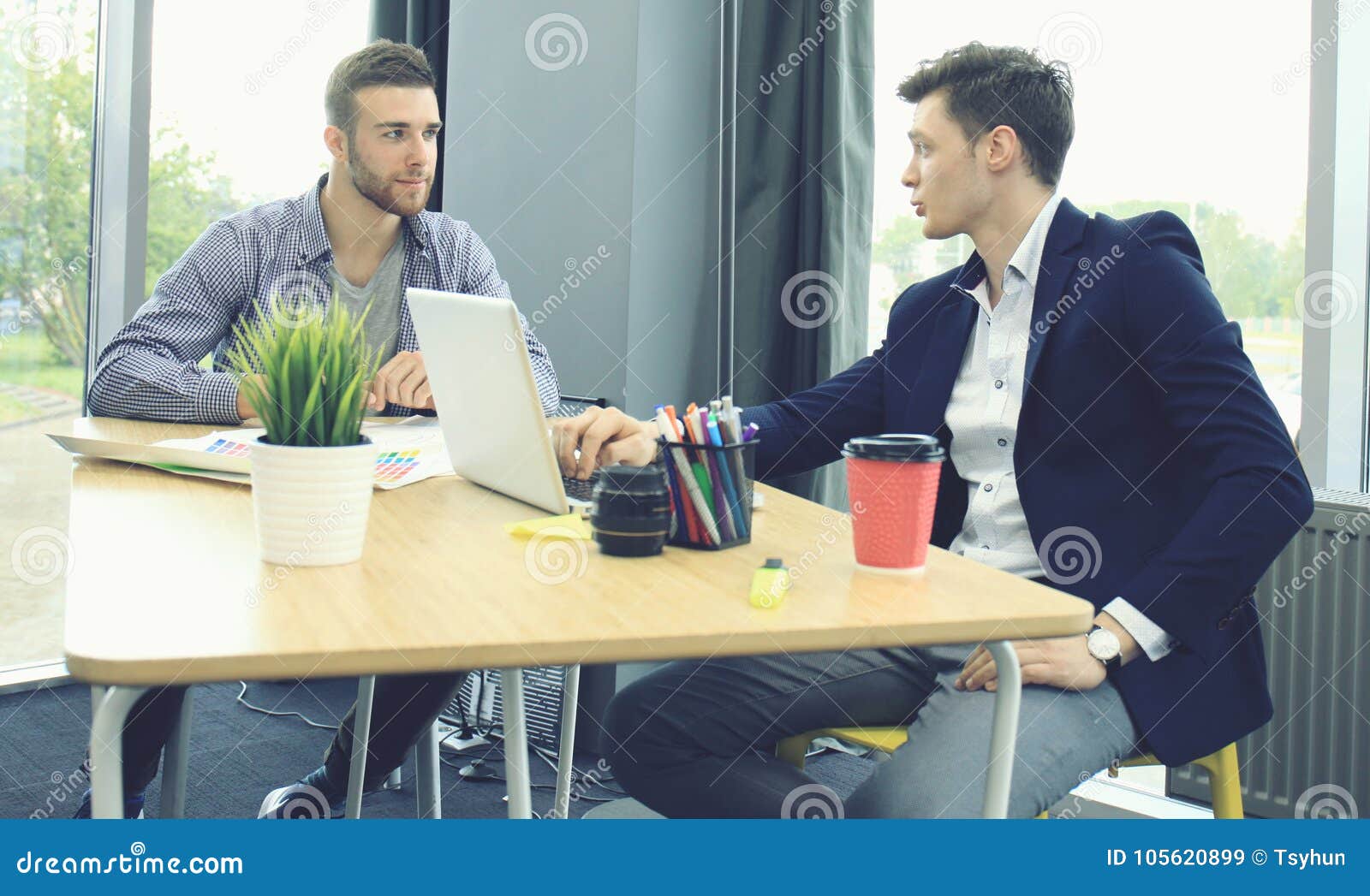 Two Young Modern Men Discussing Work in the Office Studio. Stock Image ...