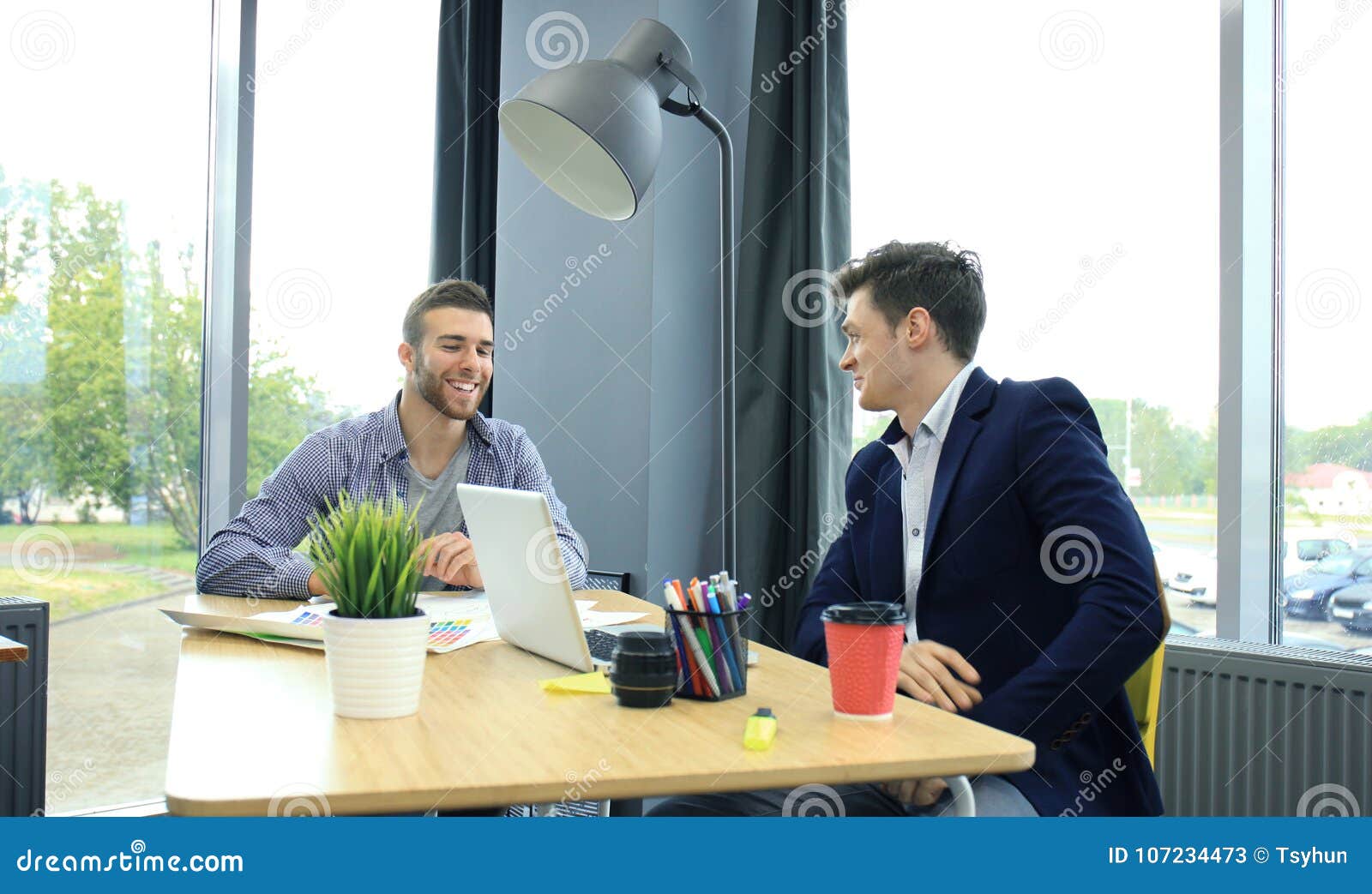 Two Young Modern Men Discussing Work in the Office Studio. Stock Image ...