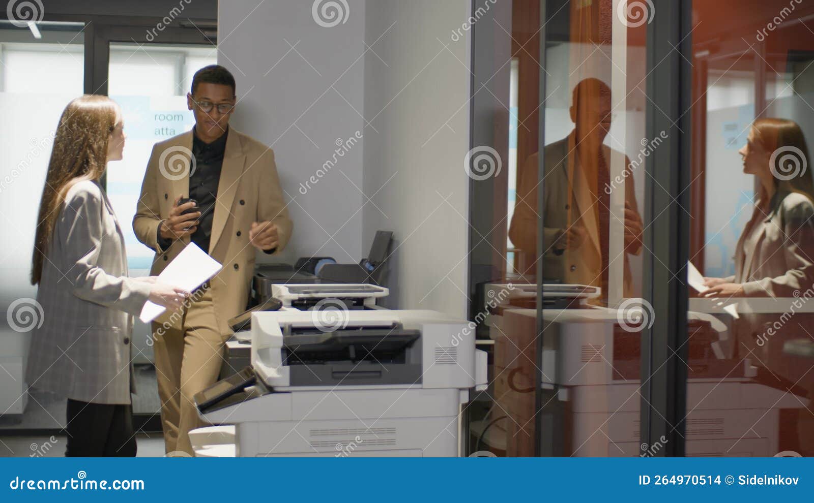 Two Young Multiethnic Colleagues is Copying Documents at Office ...