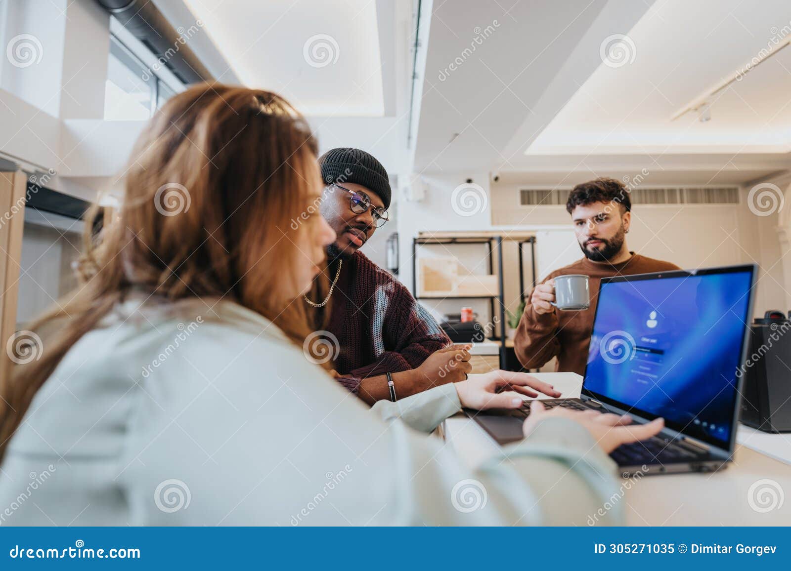 Two Young People Collaborate in a Modern Workspace, Exchanging Ideas in ...