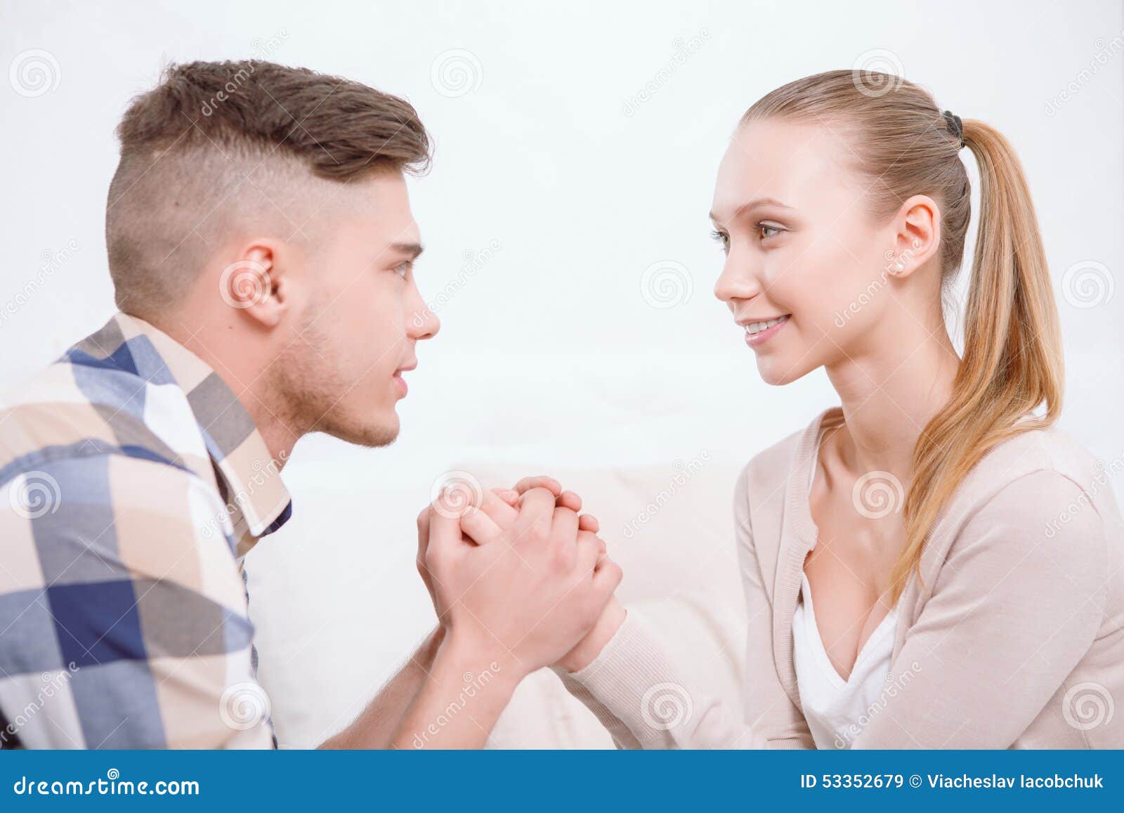 Two Young People Sitting with Embraced Hands Stock Image - Image of ...