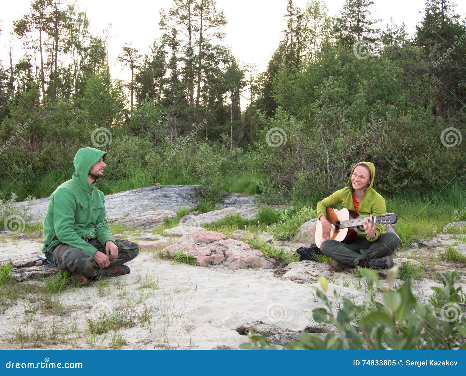 Two Young People Sitting on the Ground Stock Image - Image of ...
