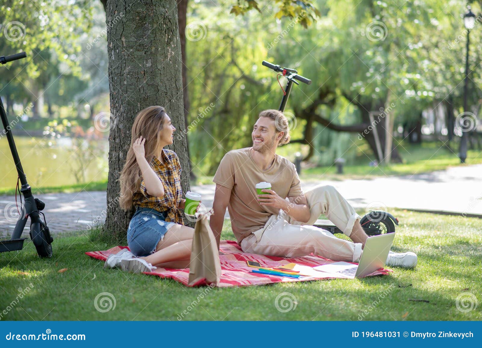 Two Young People Sitting Under the Tree and Talking Stock Image - Image ...