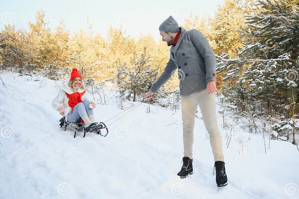Two Young People Sliding on a Sled Stock Photo - Image of outdoors ...