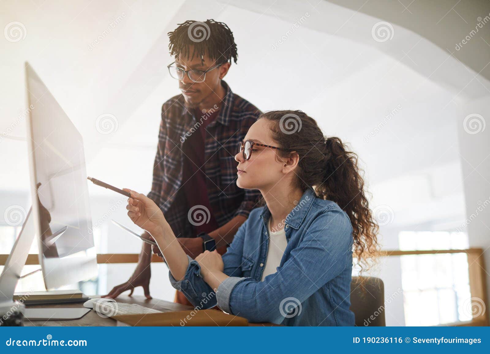 Two Young People Using PC in Office Side View Stock Photo - Image of ...