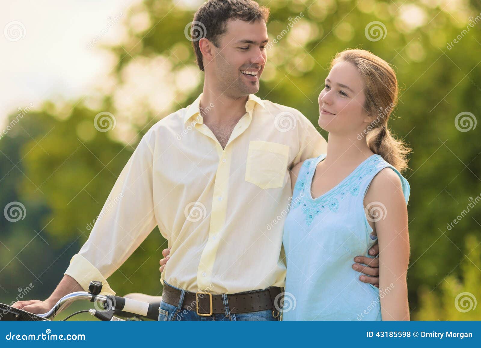 Two Young People Walking in the Park Together Embraced and Smiling ...