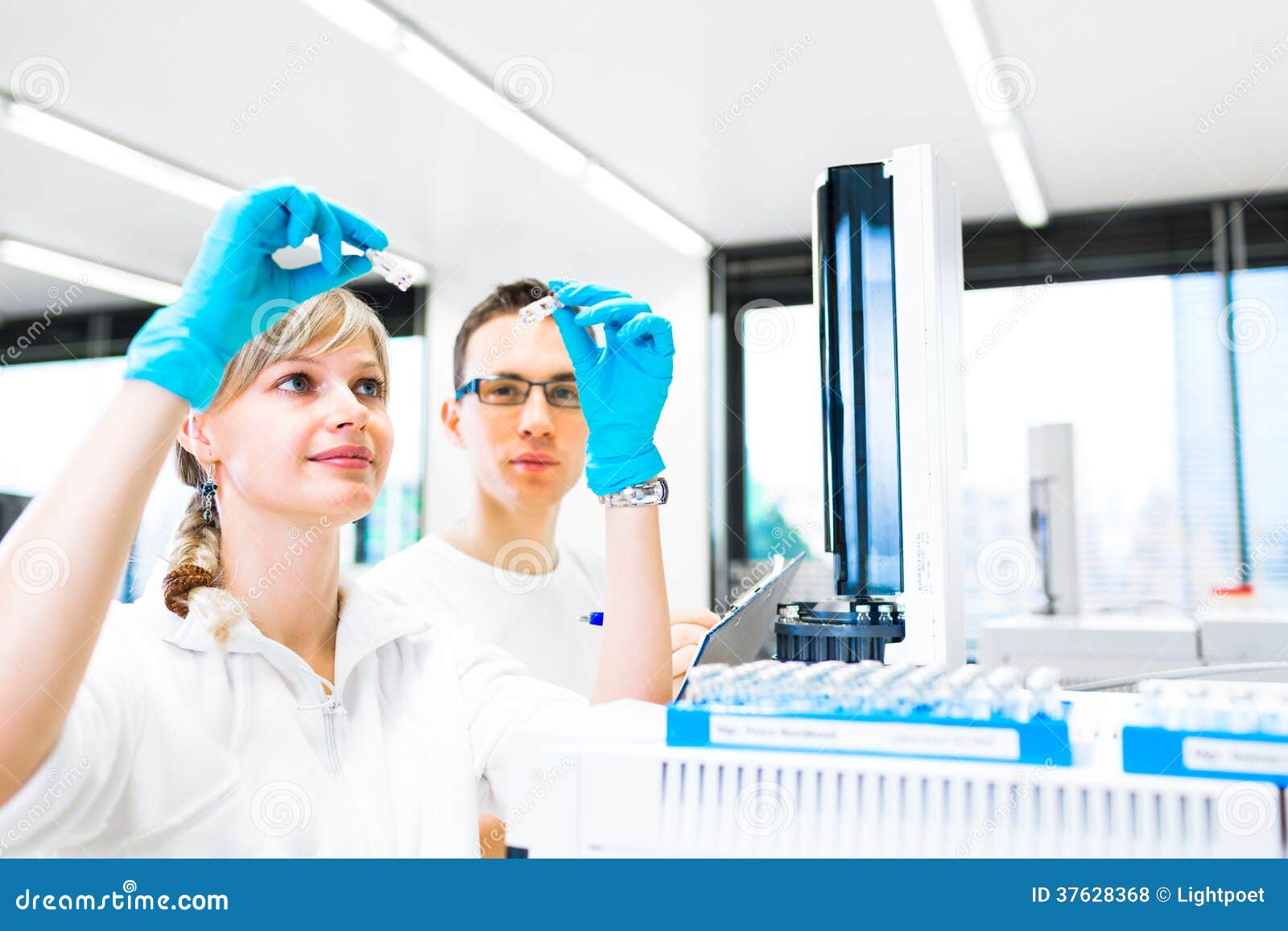 Two Young Researchers Carrying Out Experiments in a Lab Stock Photo ...