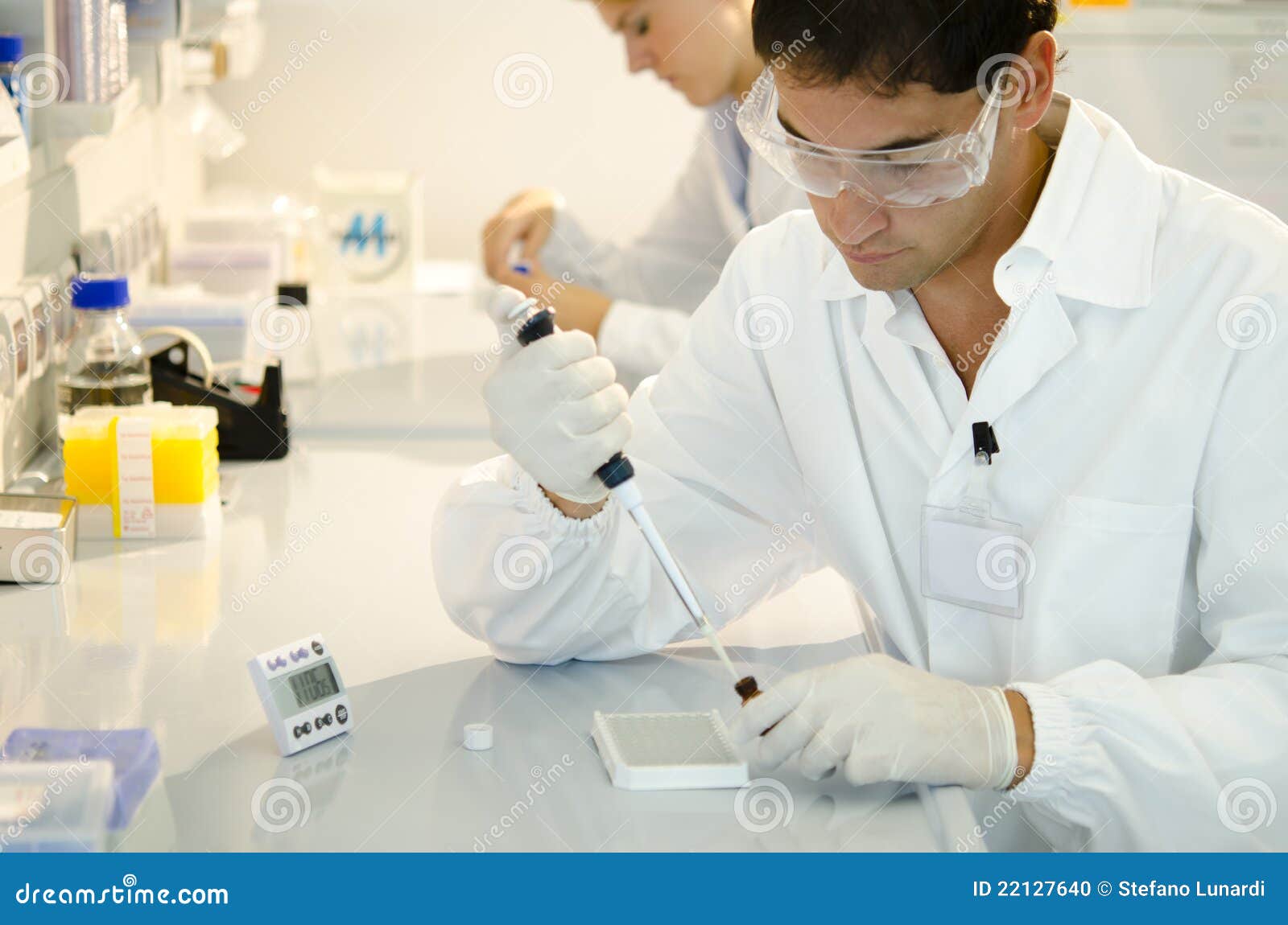 Two Young Researchers at Work Stock Photo - Image of glove, scientific ...