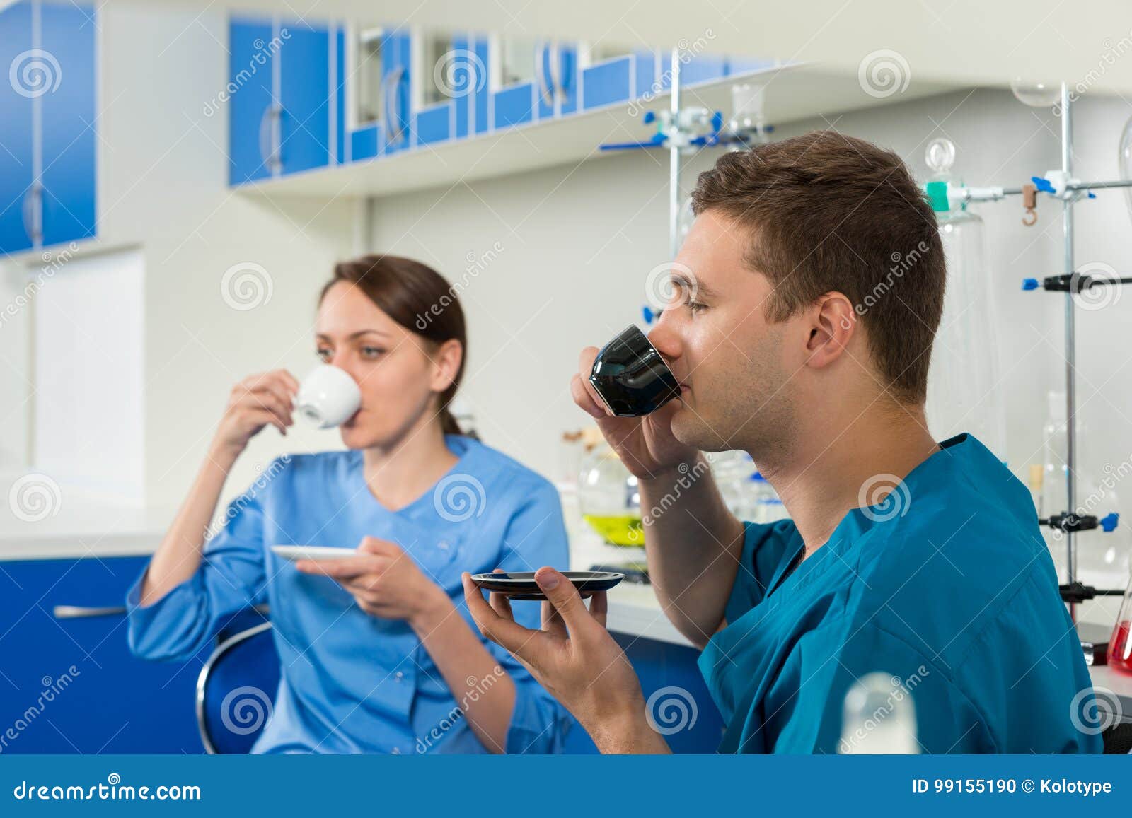 Two Young Scientists in Uniform Drinking a Coffee after Some Res Stock ...