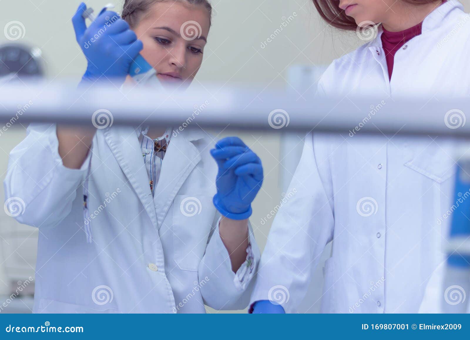 Two Young Scientists Working in a Laboratory and Doing Research ... Two Young Scientists Working in a Laboratory and Doing Research ...