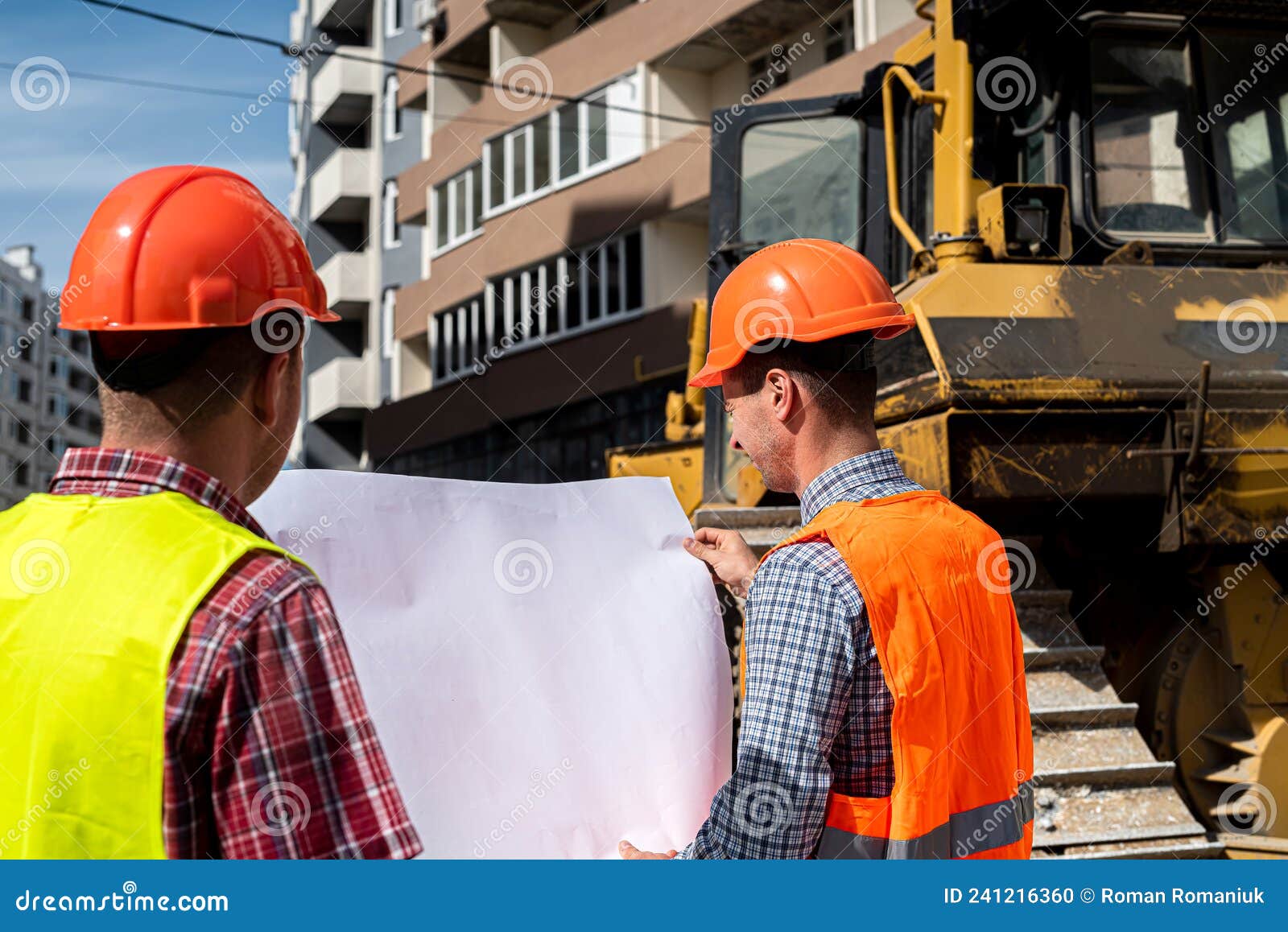 Two Young Smart Workers in Uniform Standing on a Construction Site ...