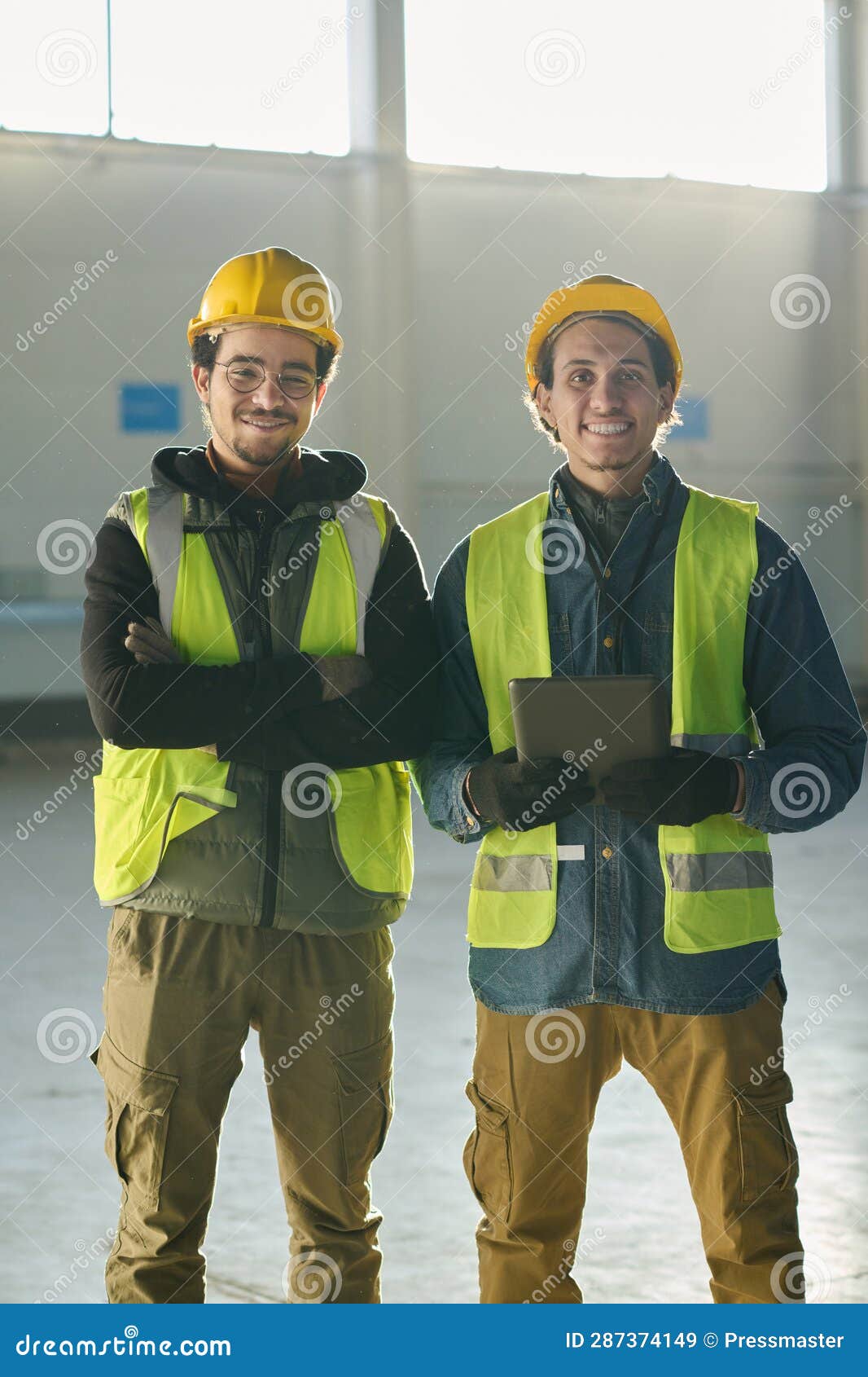 Two Young Smiling Multiethnic Engineers Standing in Front of Camera Stock Image - Image of ...