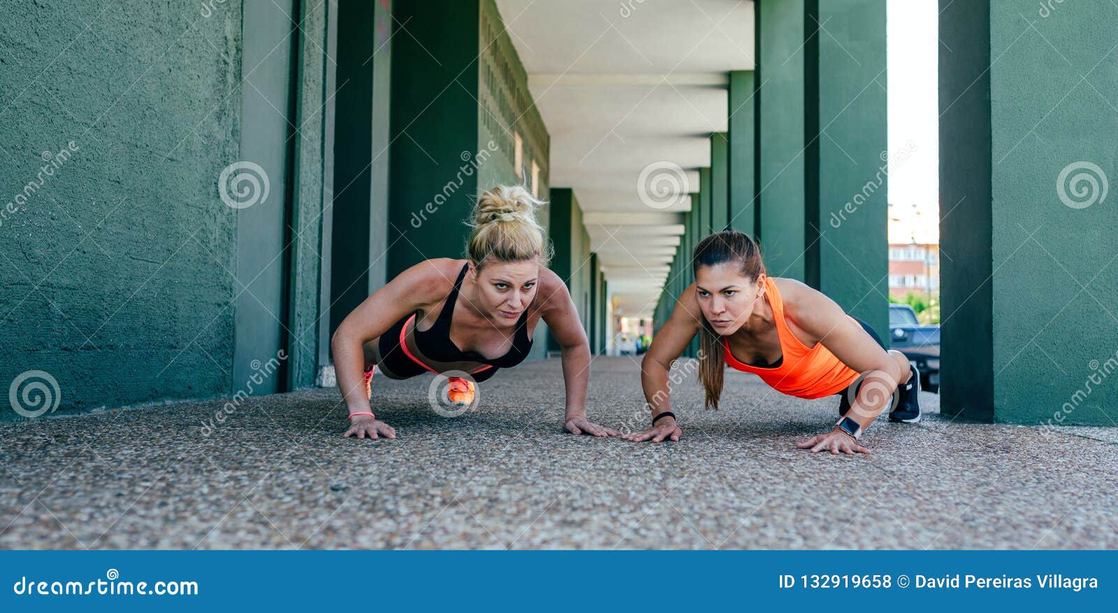 Sportswomen doing push-ups stock photo. Image of multiracial - 132919658