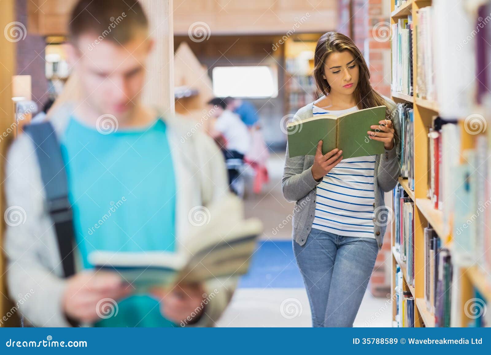 Two Young Students by Bookshelf in the Library Stock Image - Image of ...