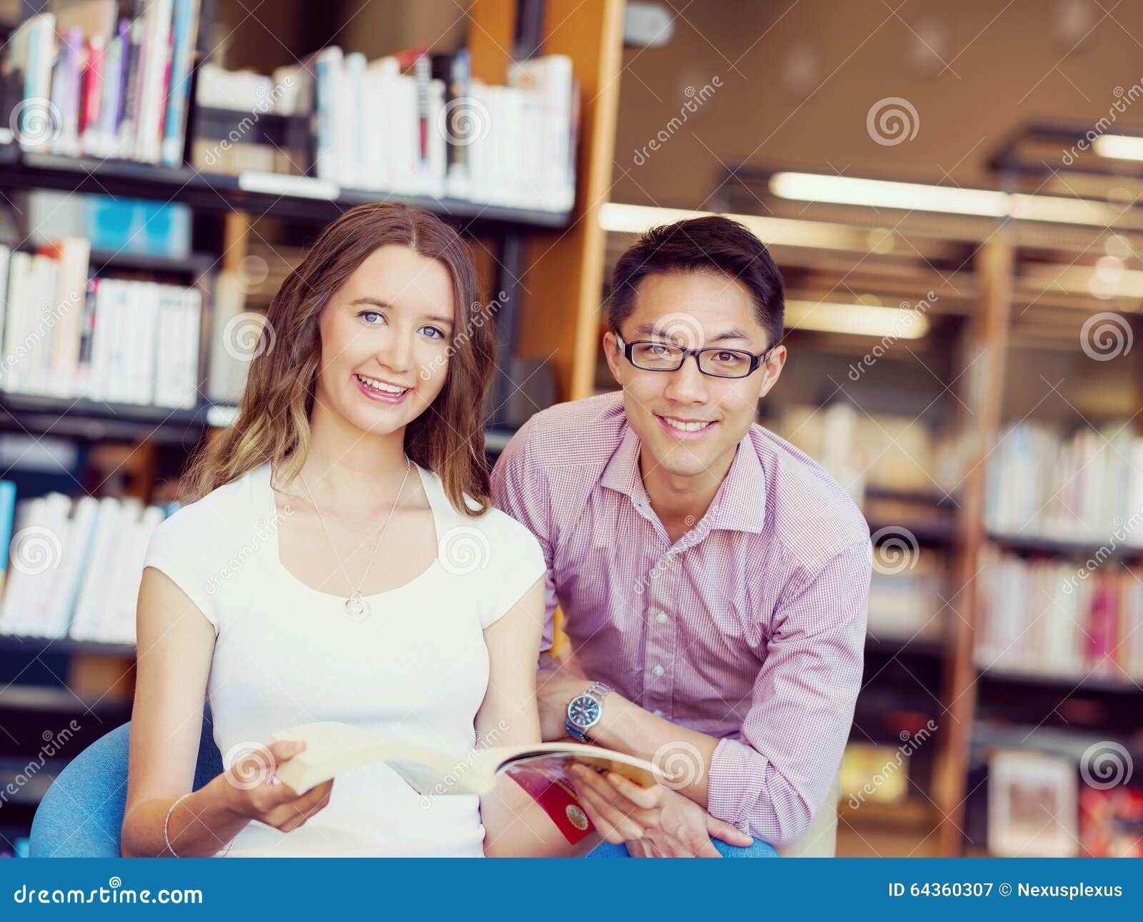 Two Young Students at the Library Stock Image - Image of bookshelf ...