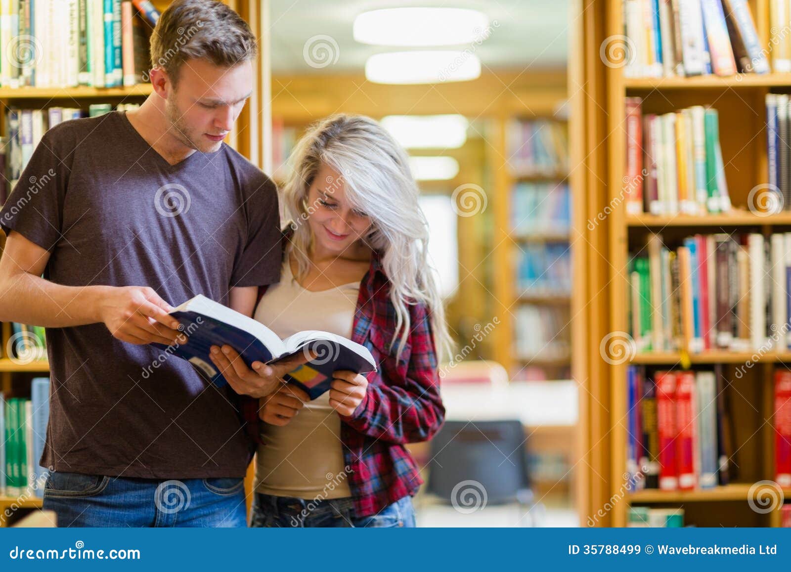 Two Young Students Reading Book in the Library Stock Image - Image of ...
