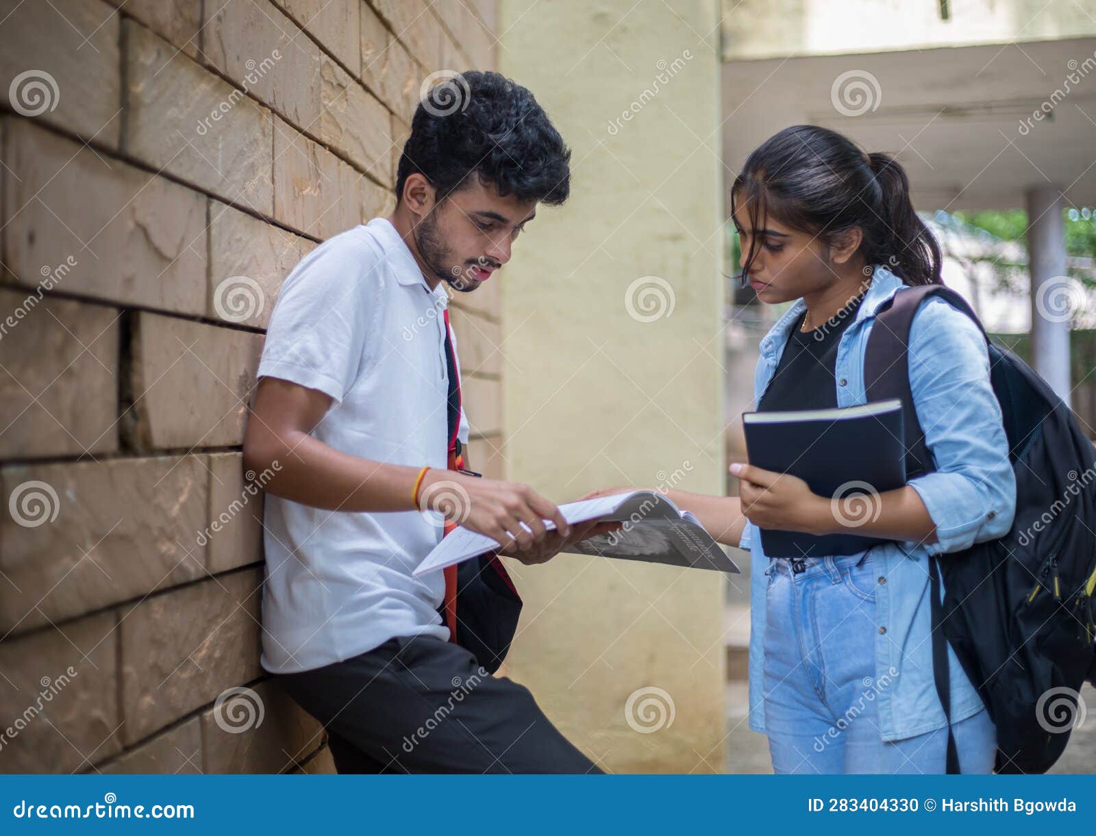 Two Young Students Reading Books in the College Campus Stock Photo ...